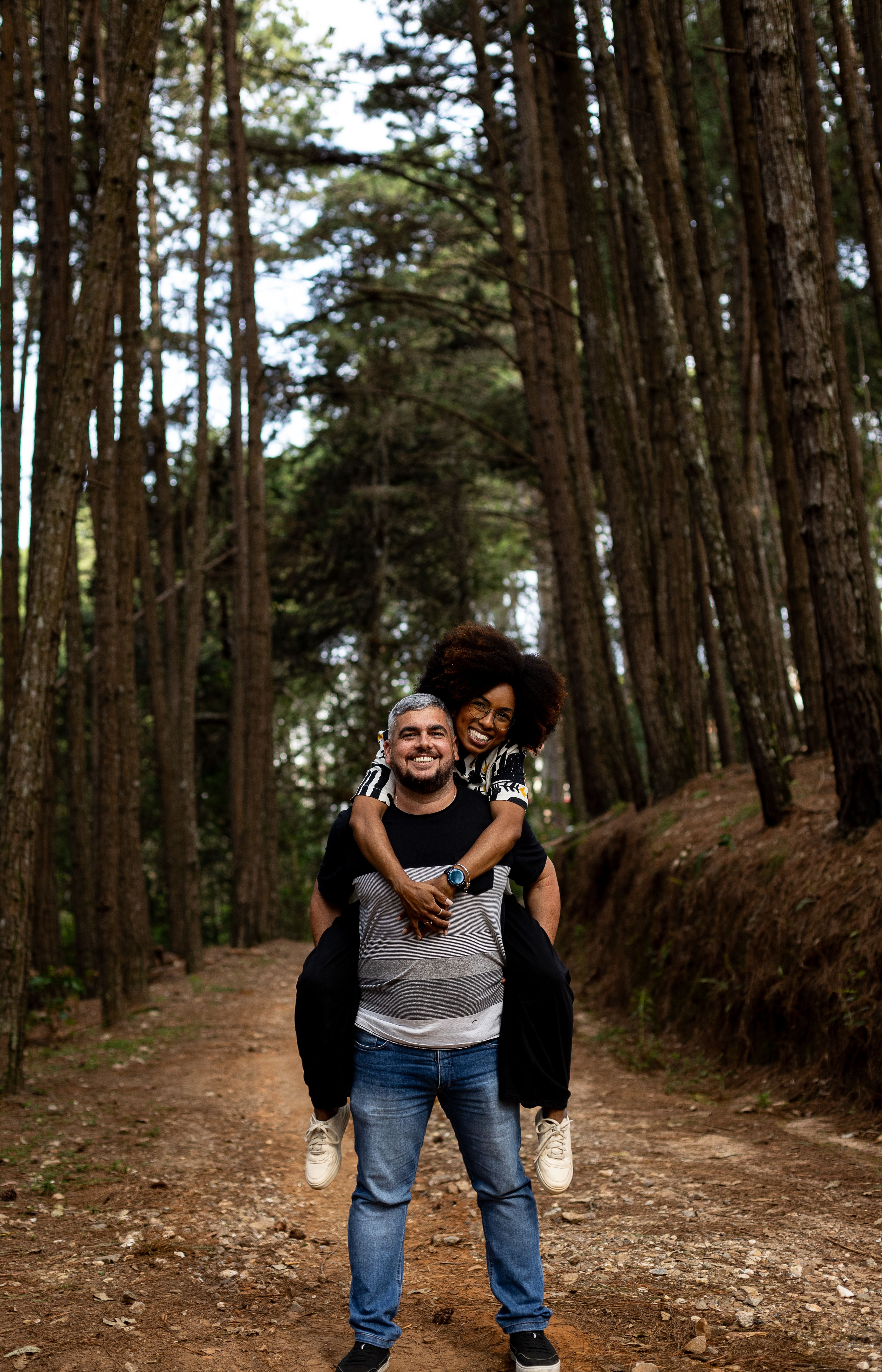 Woman Riding Piggyback on a Man in a Forest · Free Stock Photo