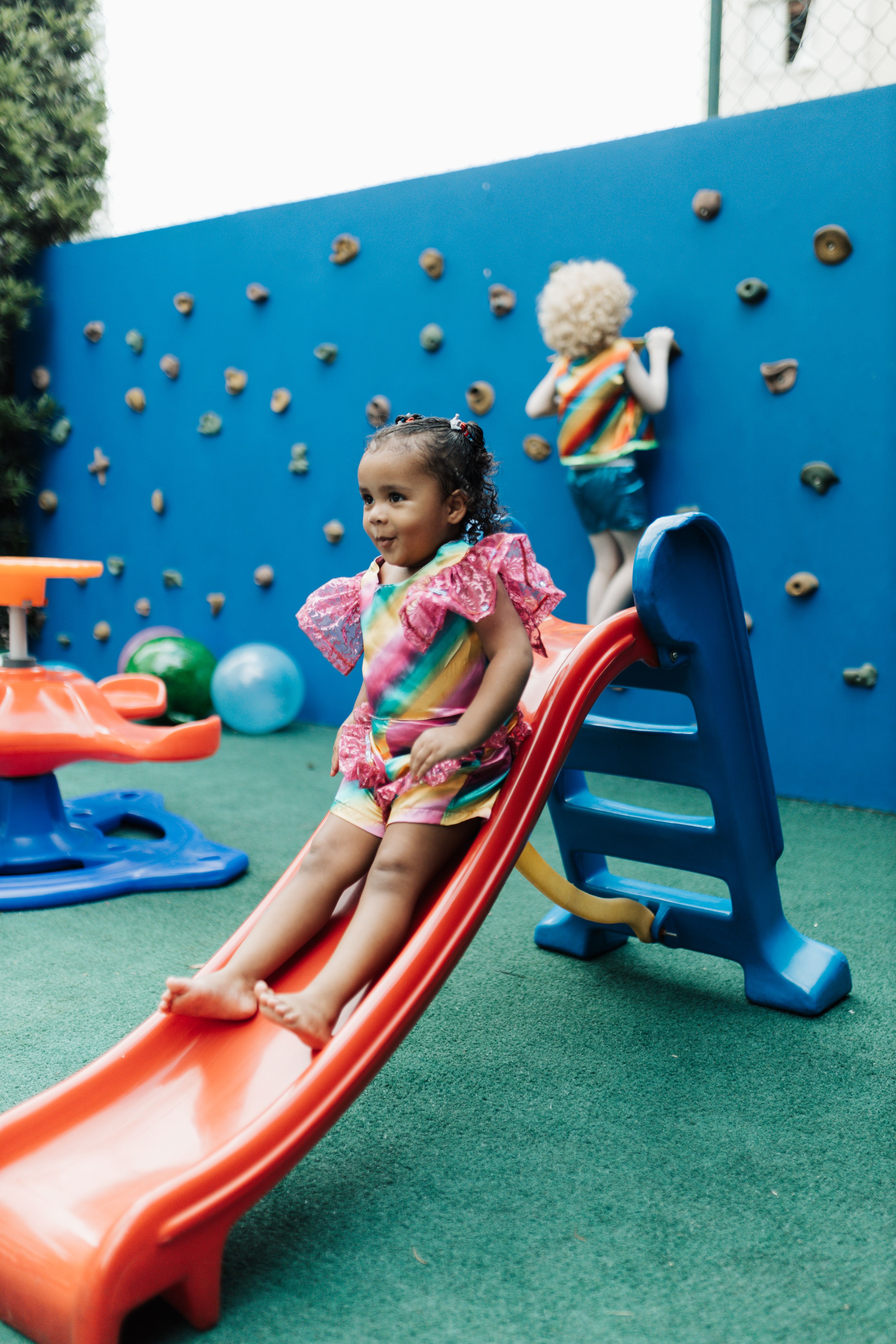 Smiling Girl Sitting on Slide · Free Stock Photo