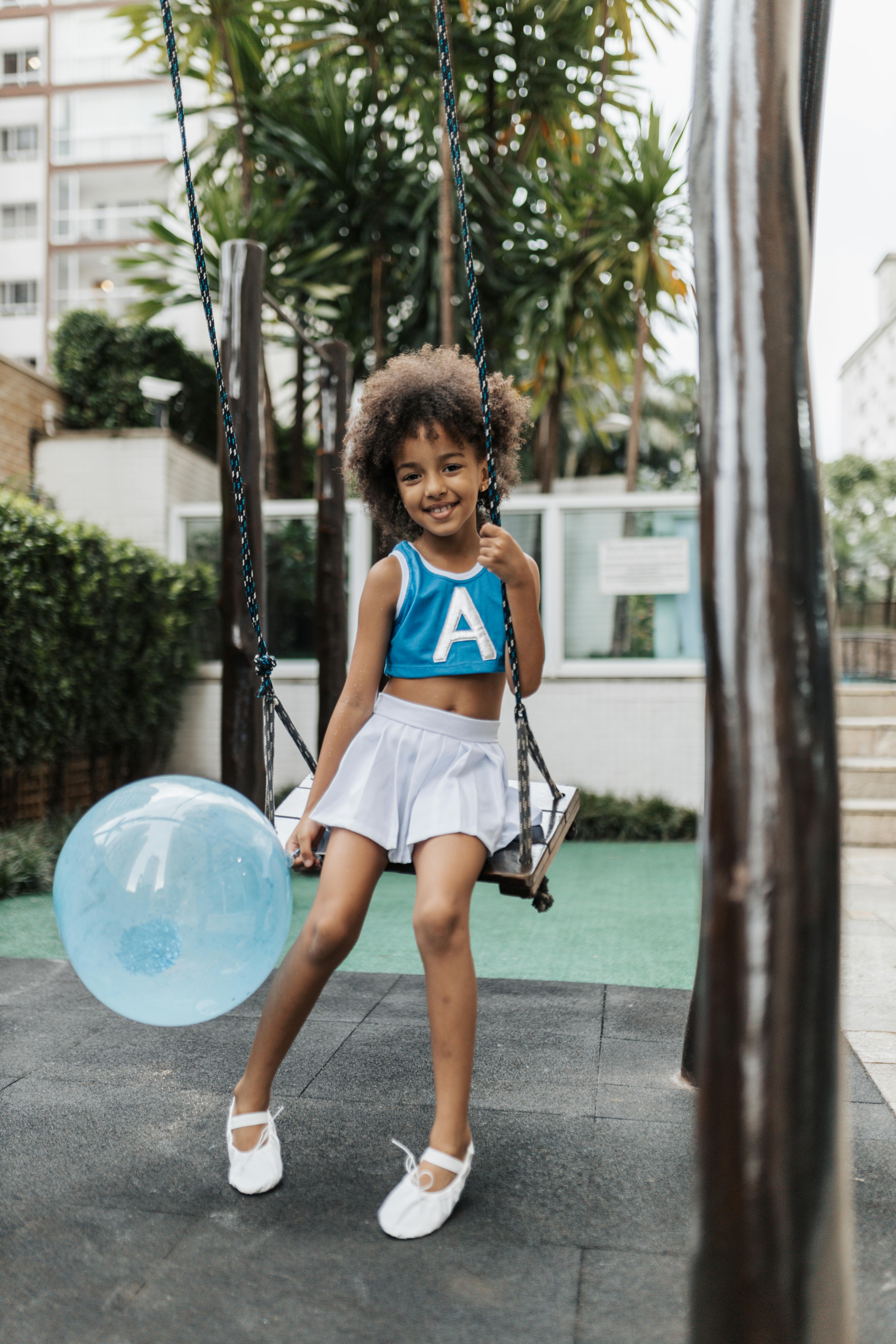 Smiling Child Model in Skirt and Cropped Top · Free Stock Photo