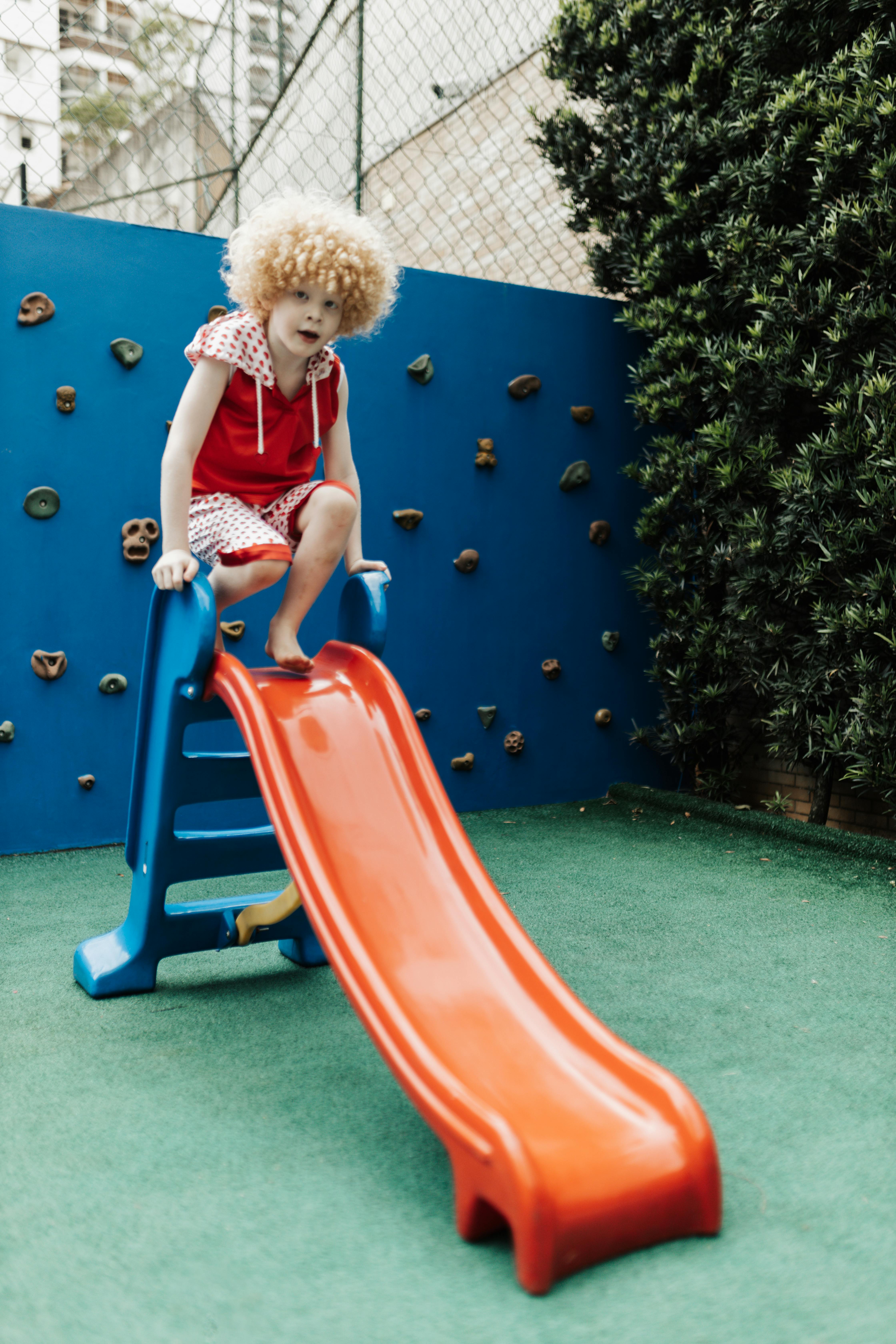 Boy Playing on Slide in Playground · Free Stock Photo