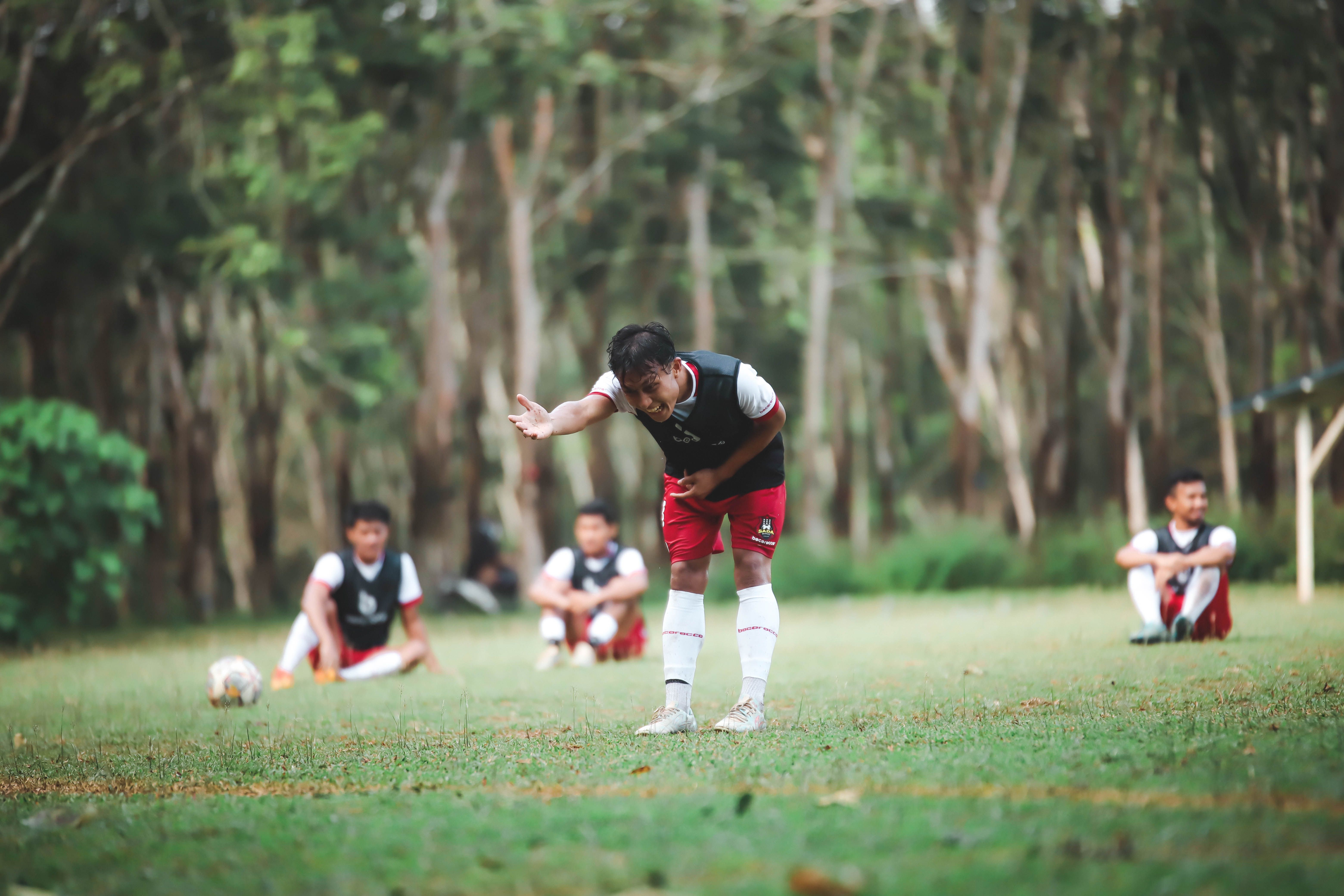 A group of people playing soccer in a field · Free Stock Photo