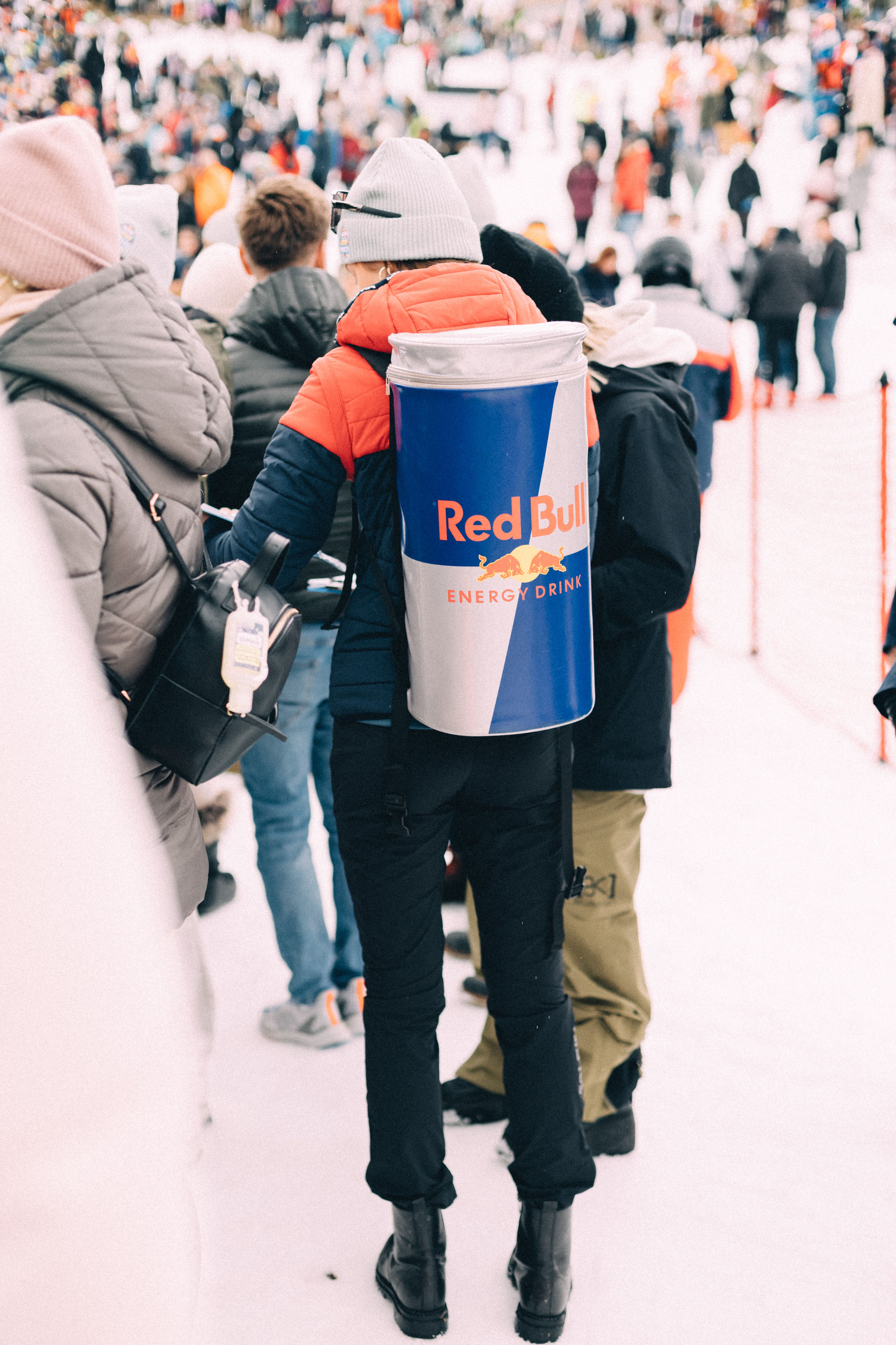 Back View of Woman with Red Bull Can Backpack in Winter · Free Stock Photo
