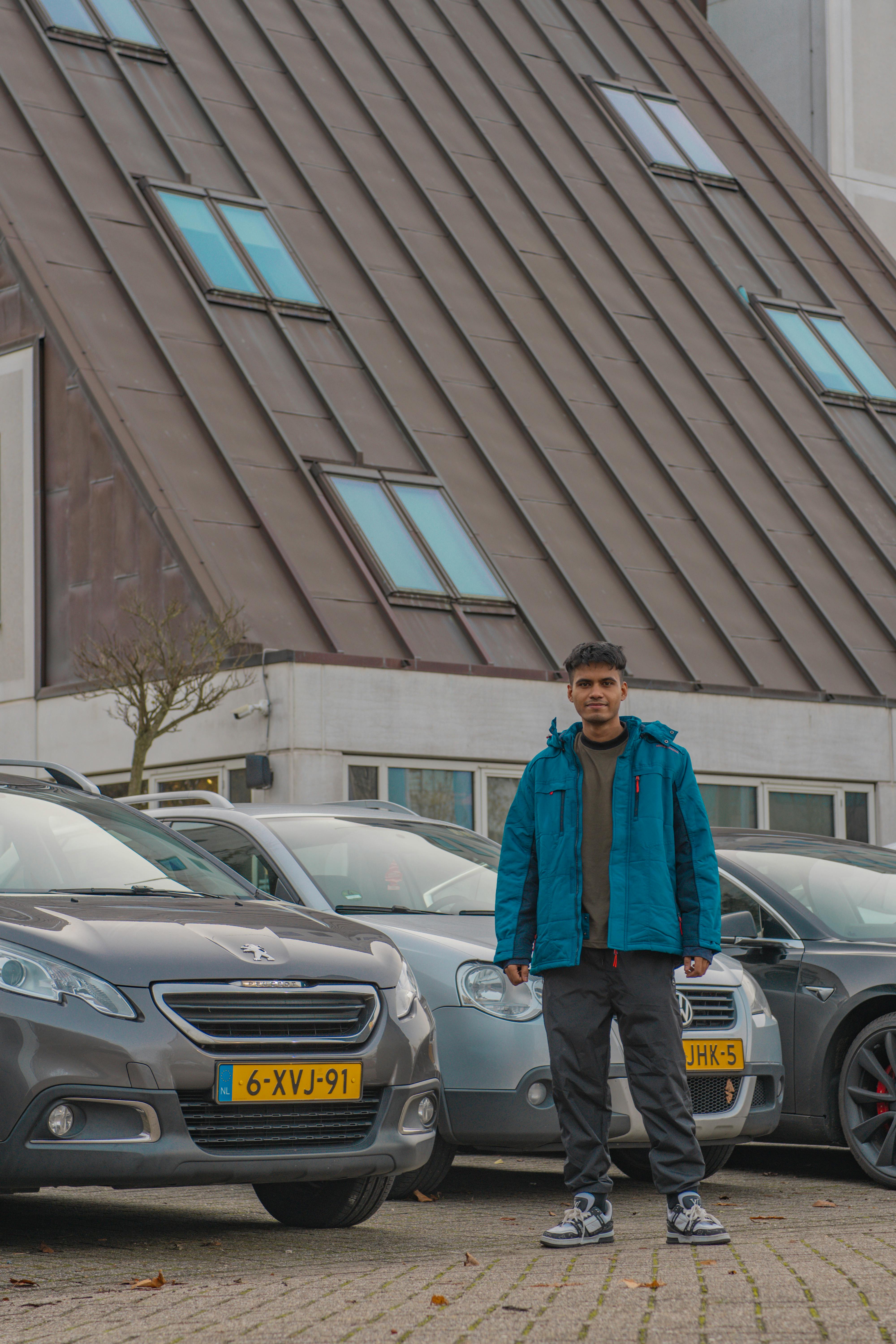 Man in Jacket Standing with Cars · Free Stock Photo