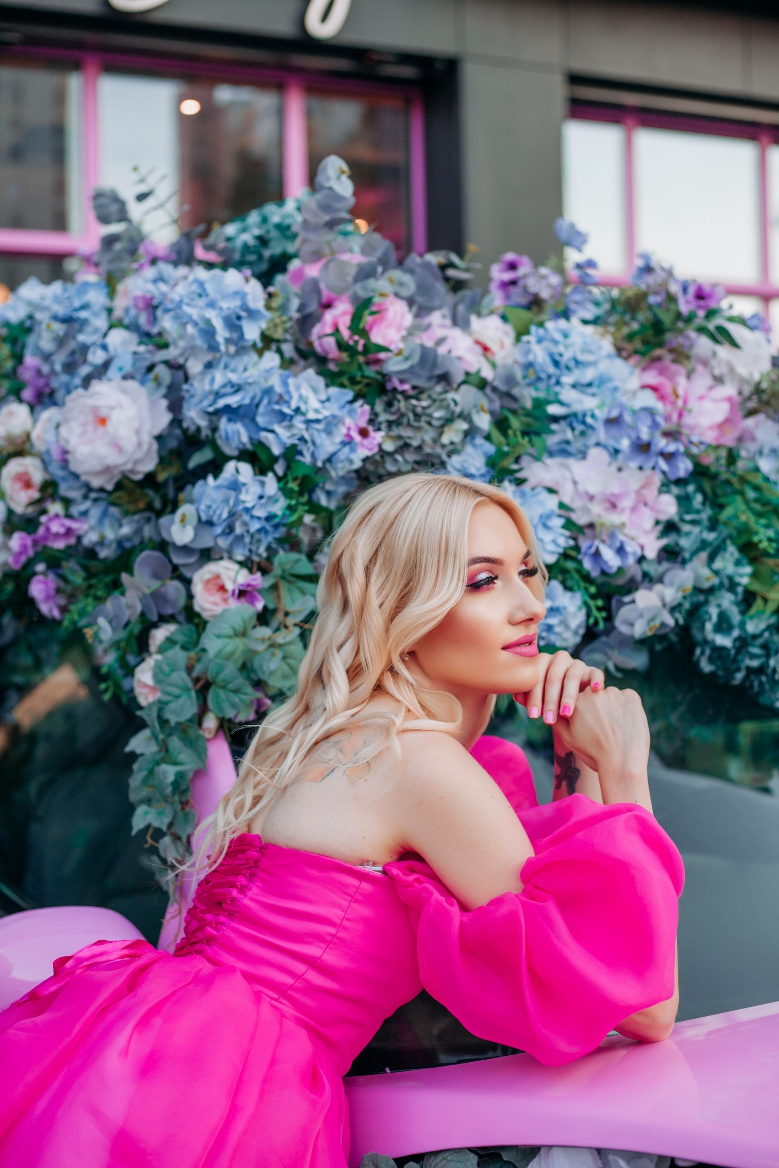 Blonde Woman in Pink Red Leaning on Pink Car · Free Stock Photo