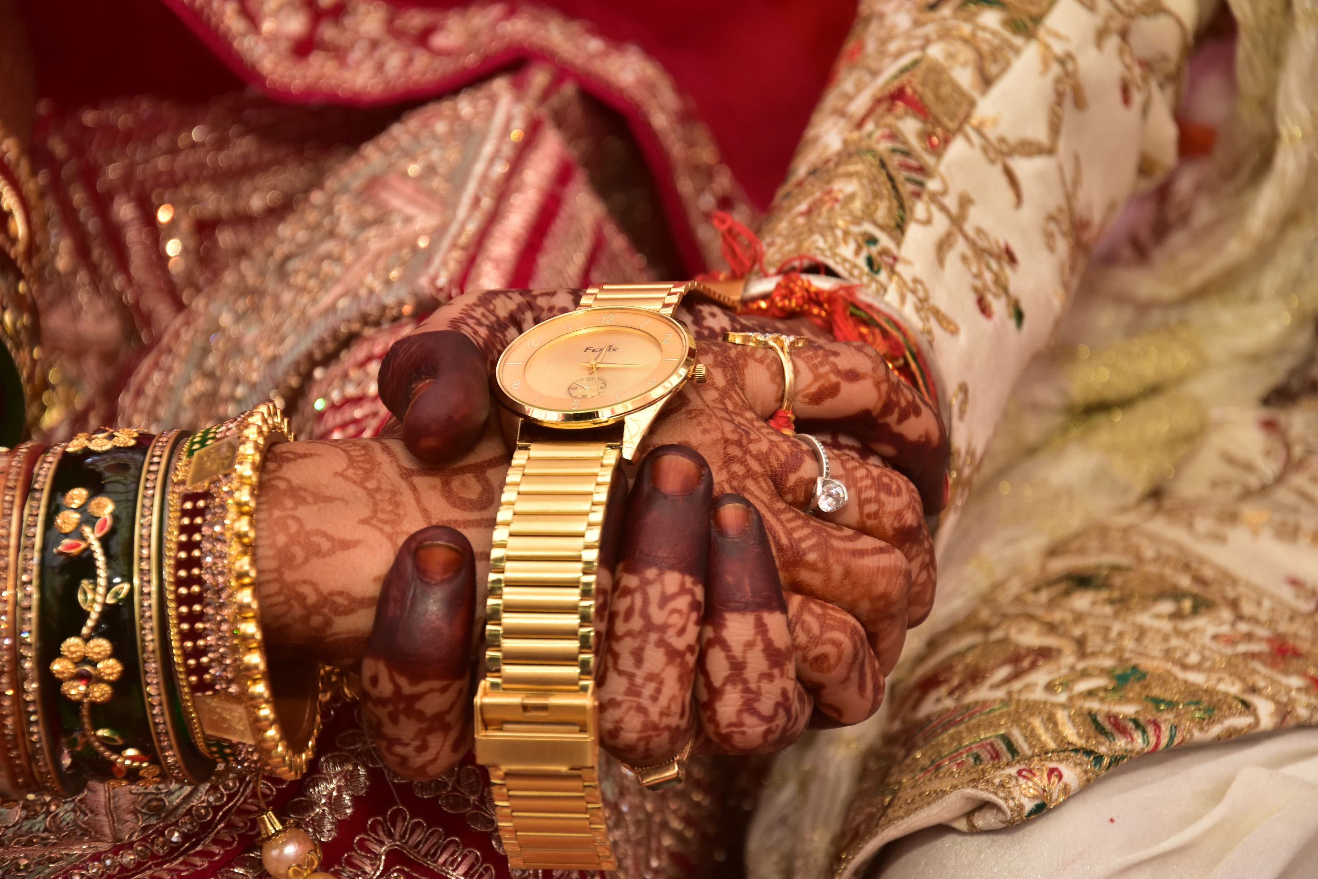 Hands of Women with Henna Tattoos Holding Golden Watch · Free Stock Photo