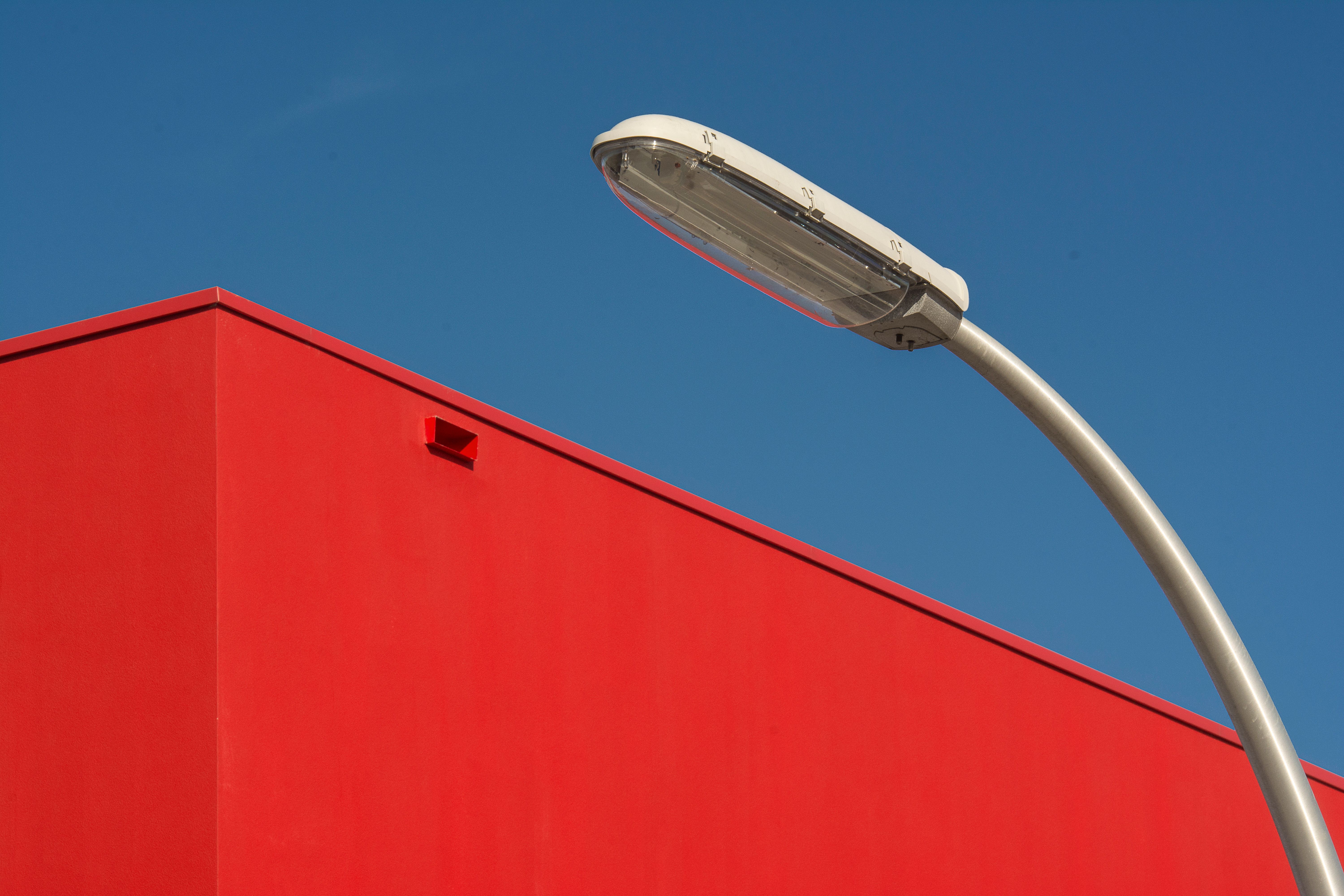 Abstract Photo of a Red Modern Building and a Lamppost · Free Stock Photo