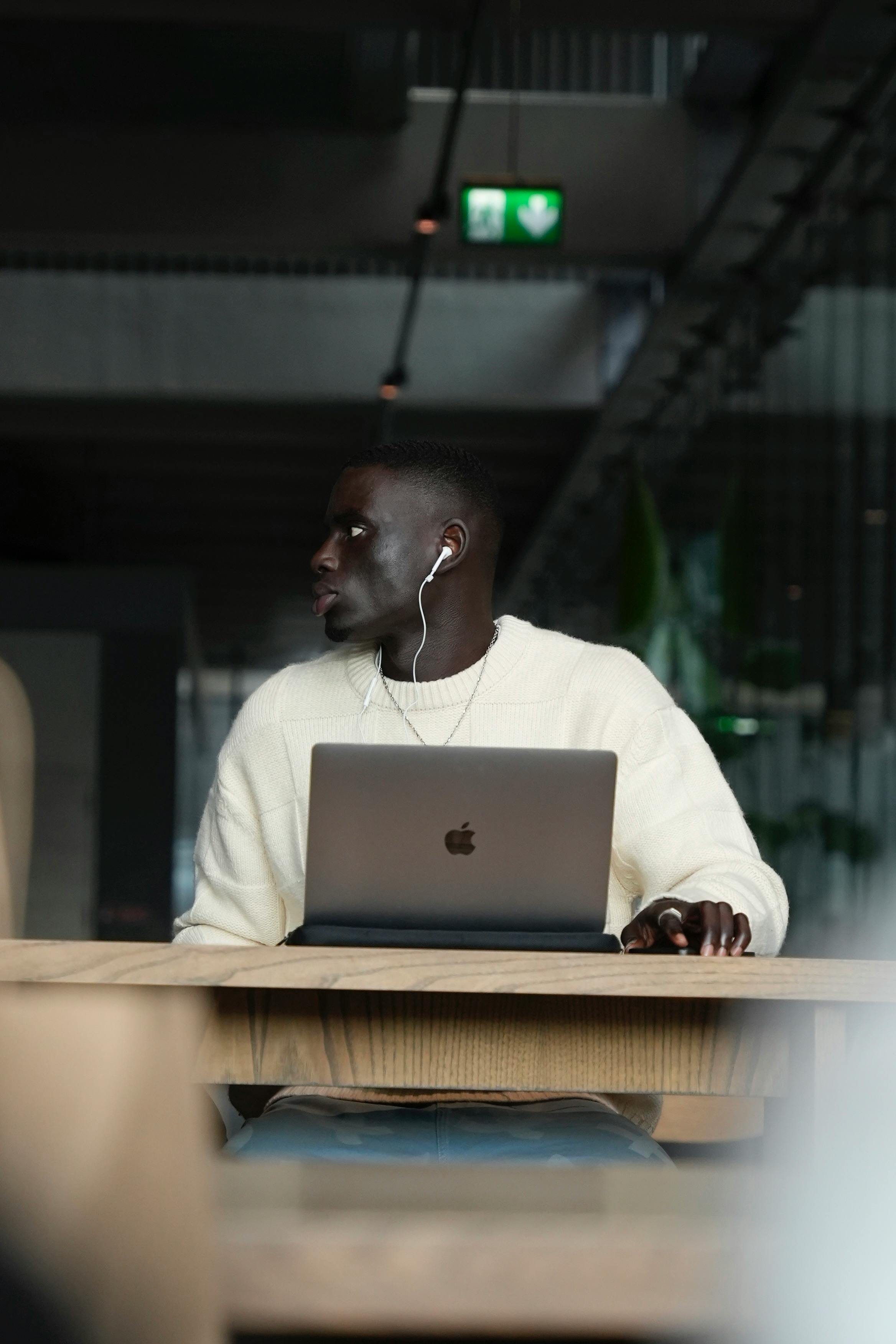 Man Sitting at Desk with Laptop · Free Stock Photo