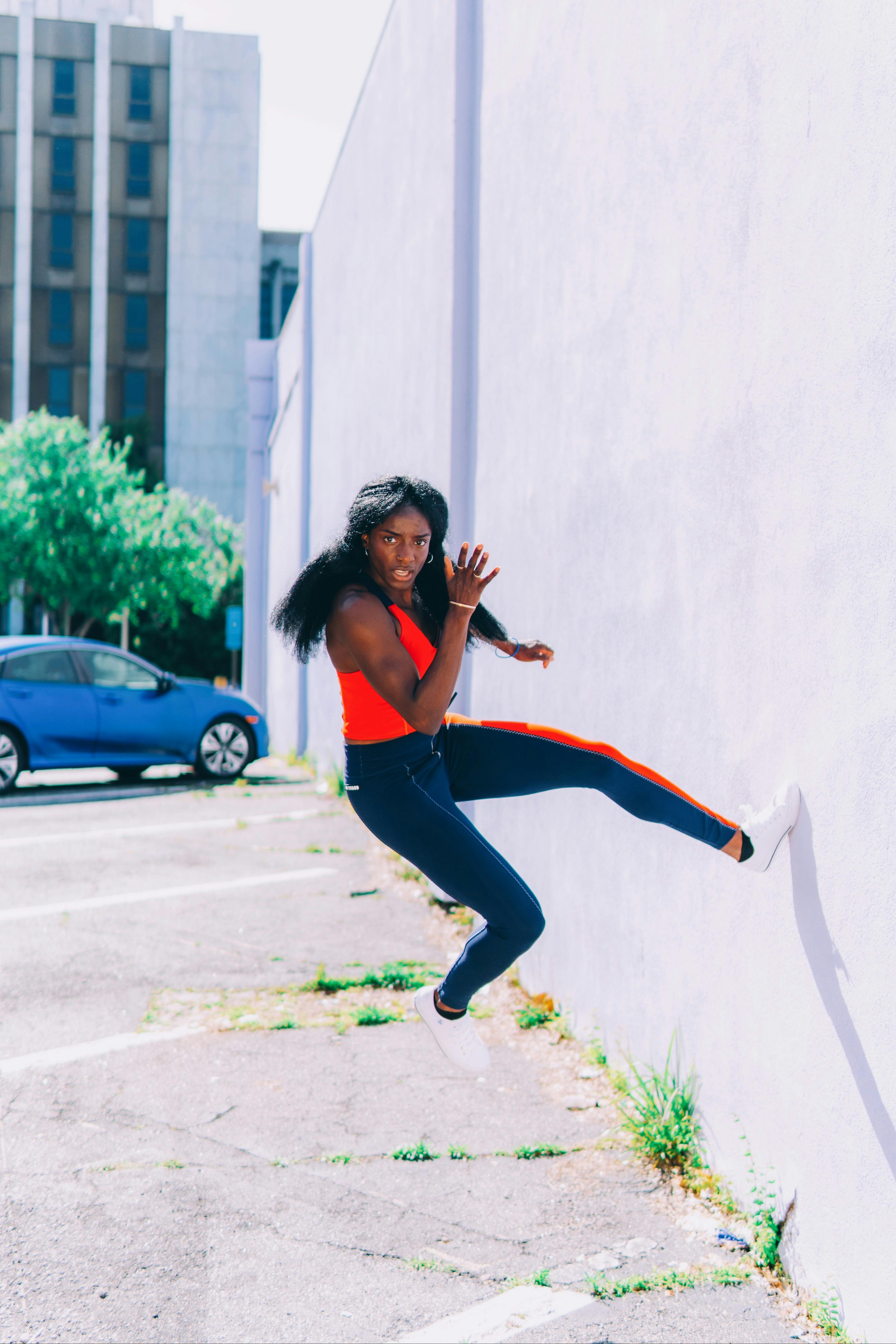 athletic women jumping off wall · Free Stock Photo