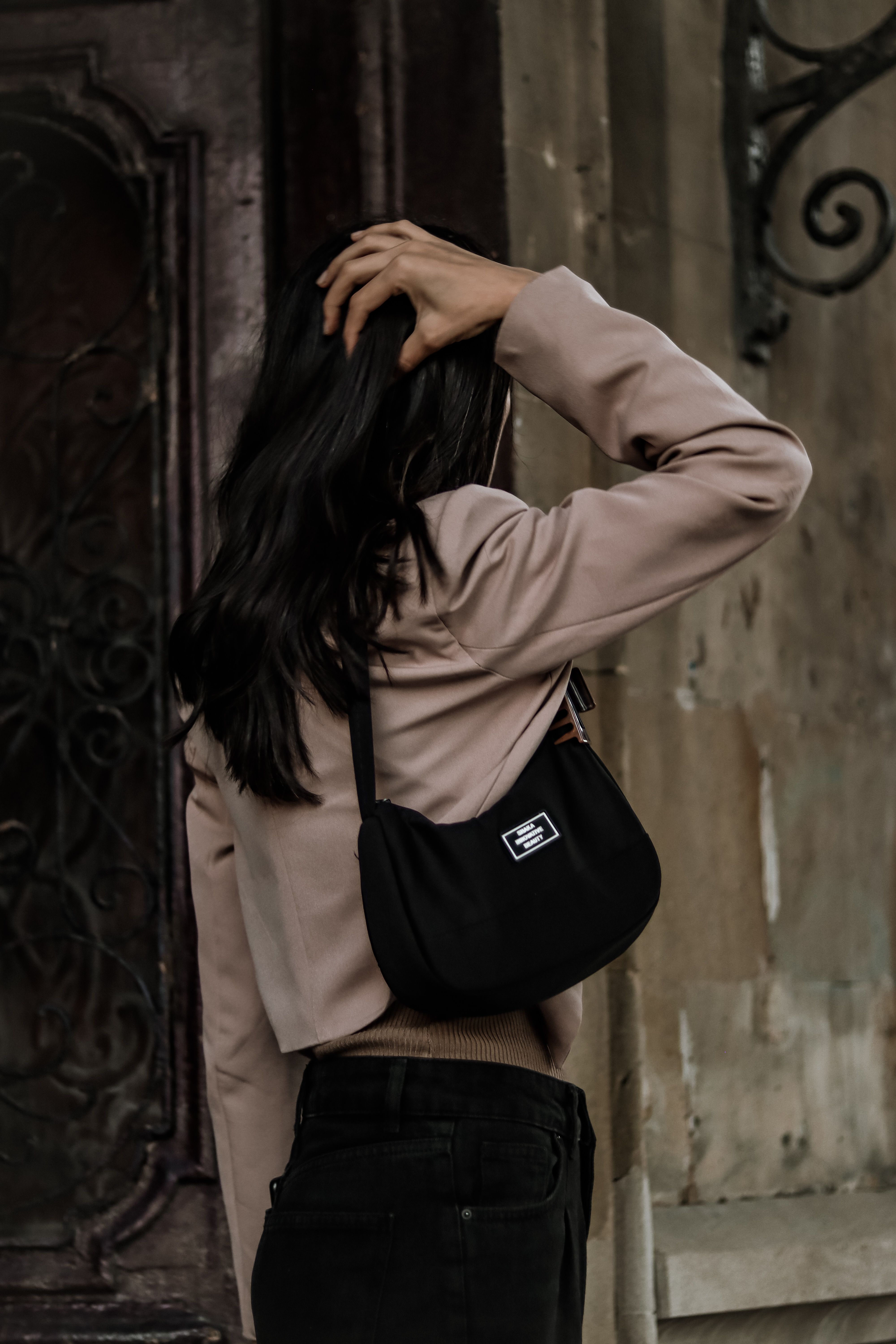 Back View of a Woman Fixing Her Hair · Free Stock Photo