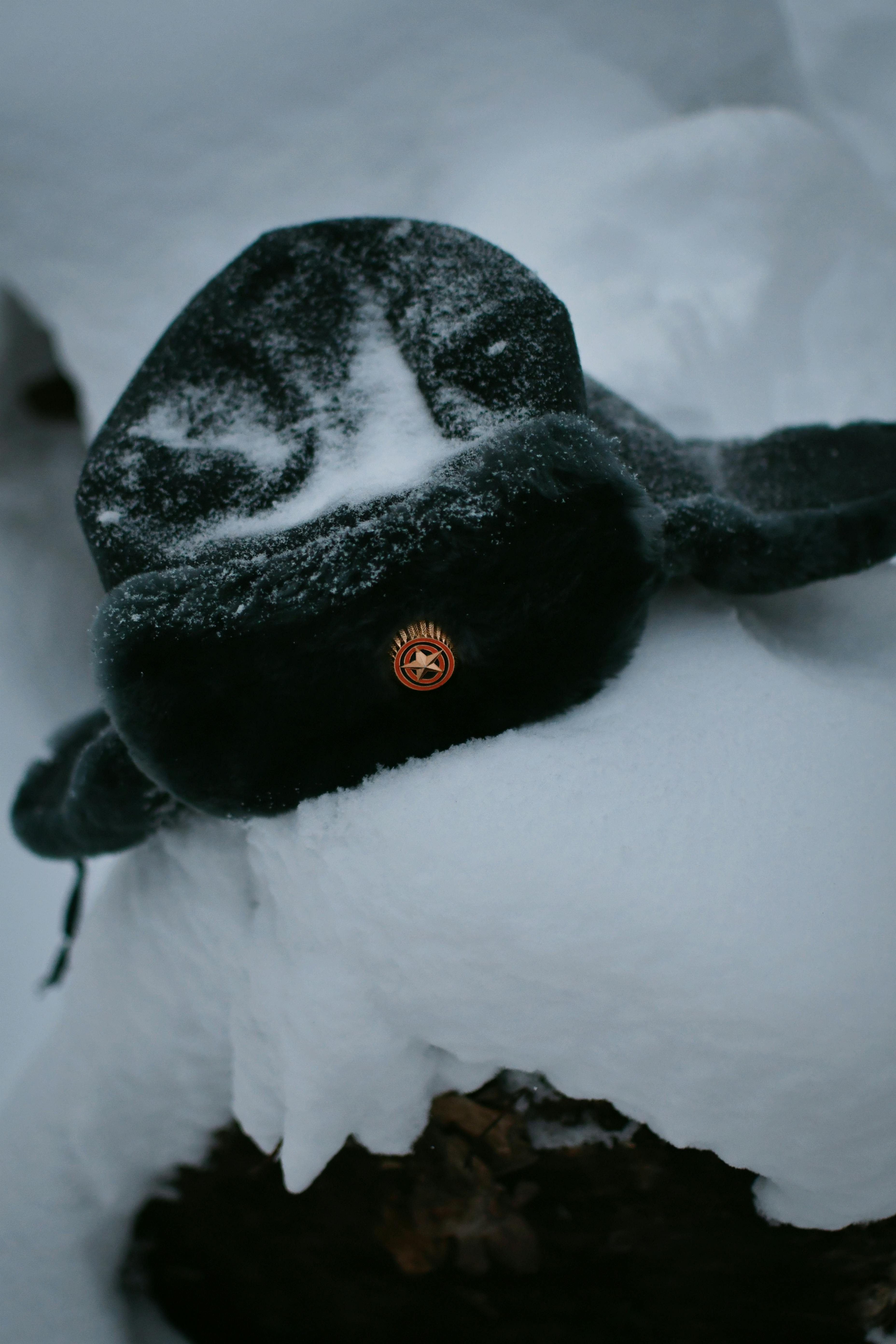 Ushanka Hat with a Star Left in the Snow · Free Stock Photo