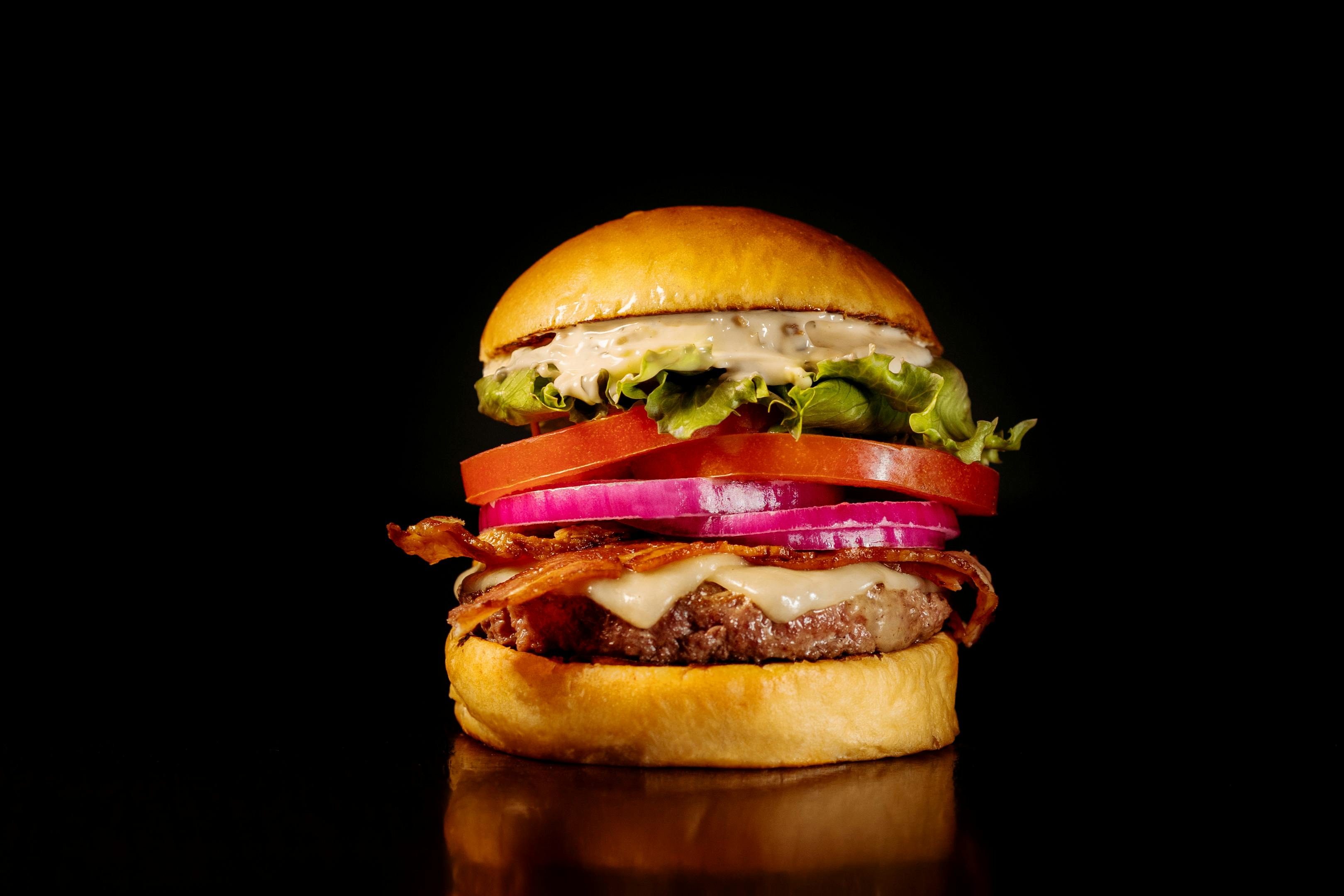 Close-up of a Burger with Cheese and Vegetables · Free Stock Photo