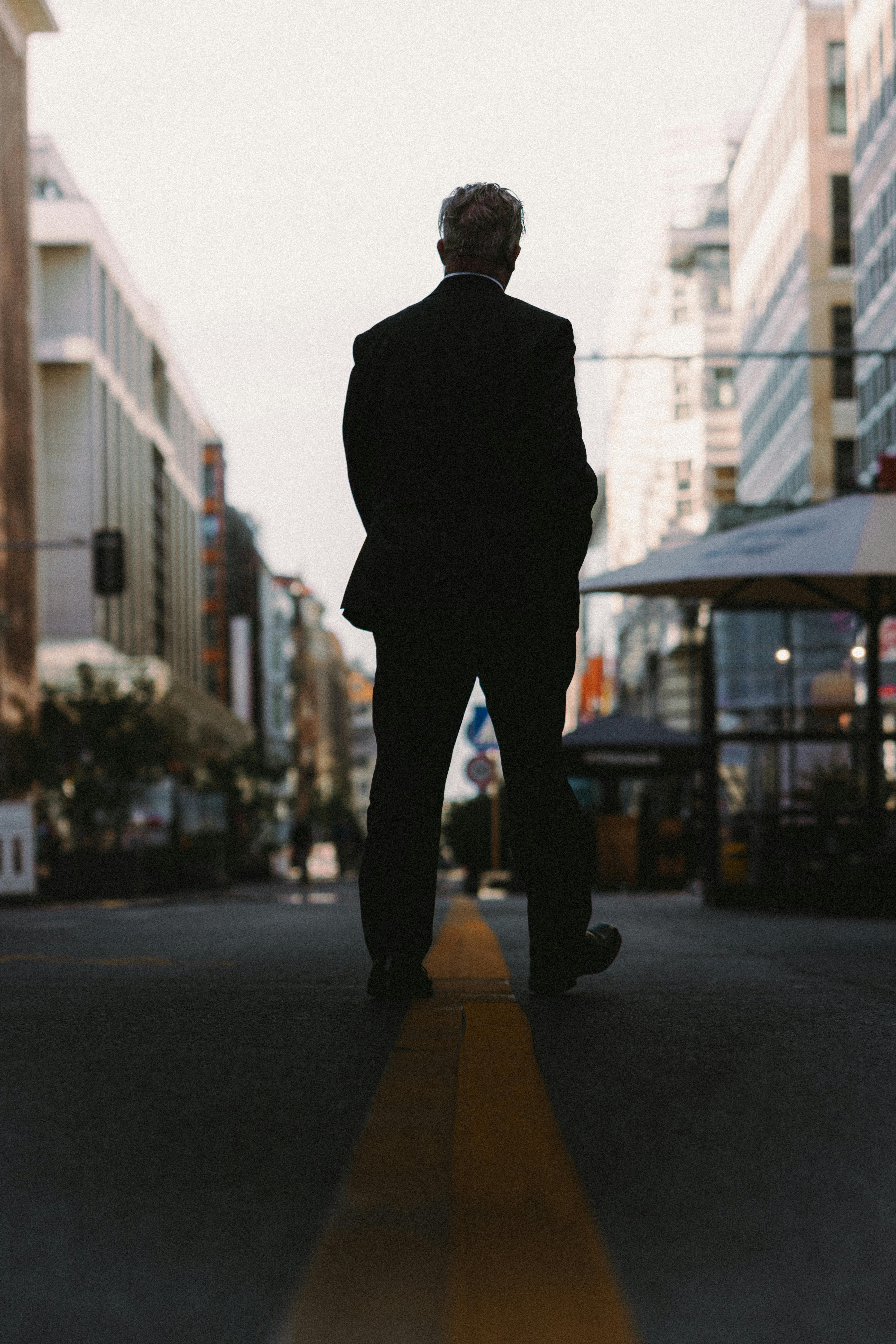 Back View of a Man Standing on the Street in City · Free Stock Photo