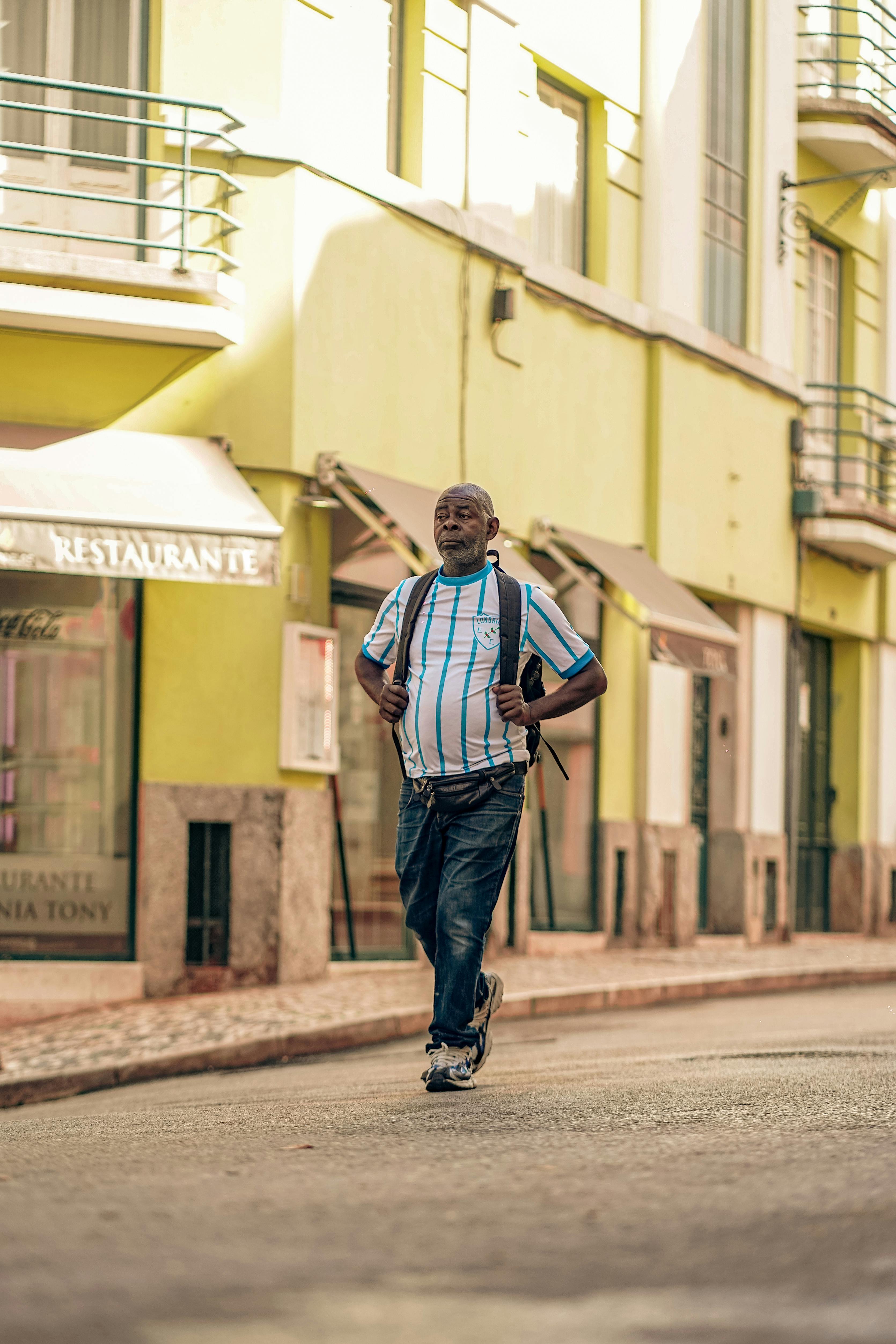 Man Walking on Pedestrian Crossing · Free Stock Photo