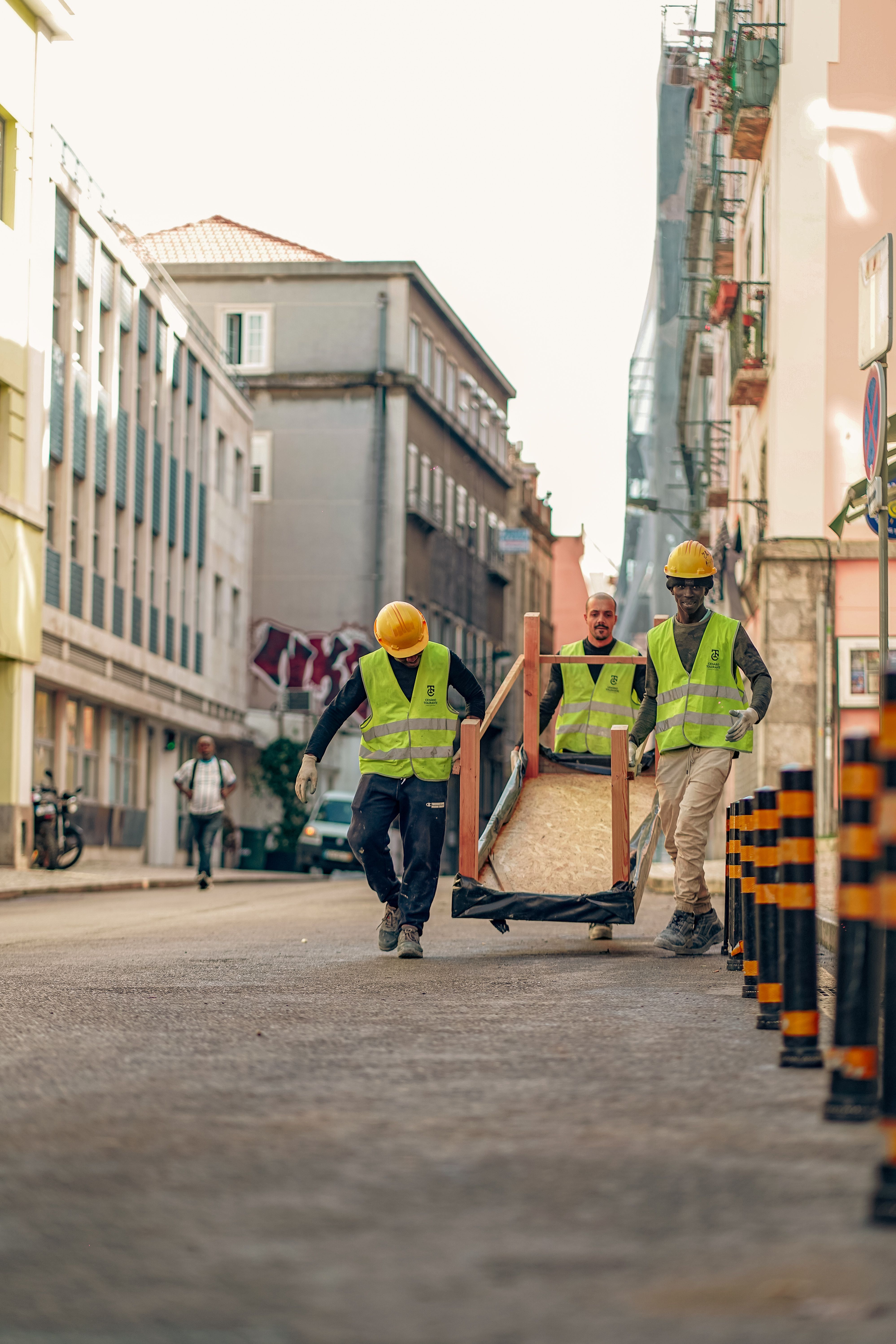 Construction Workers Carrying Table · Free Stock Photo
