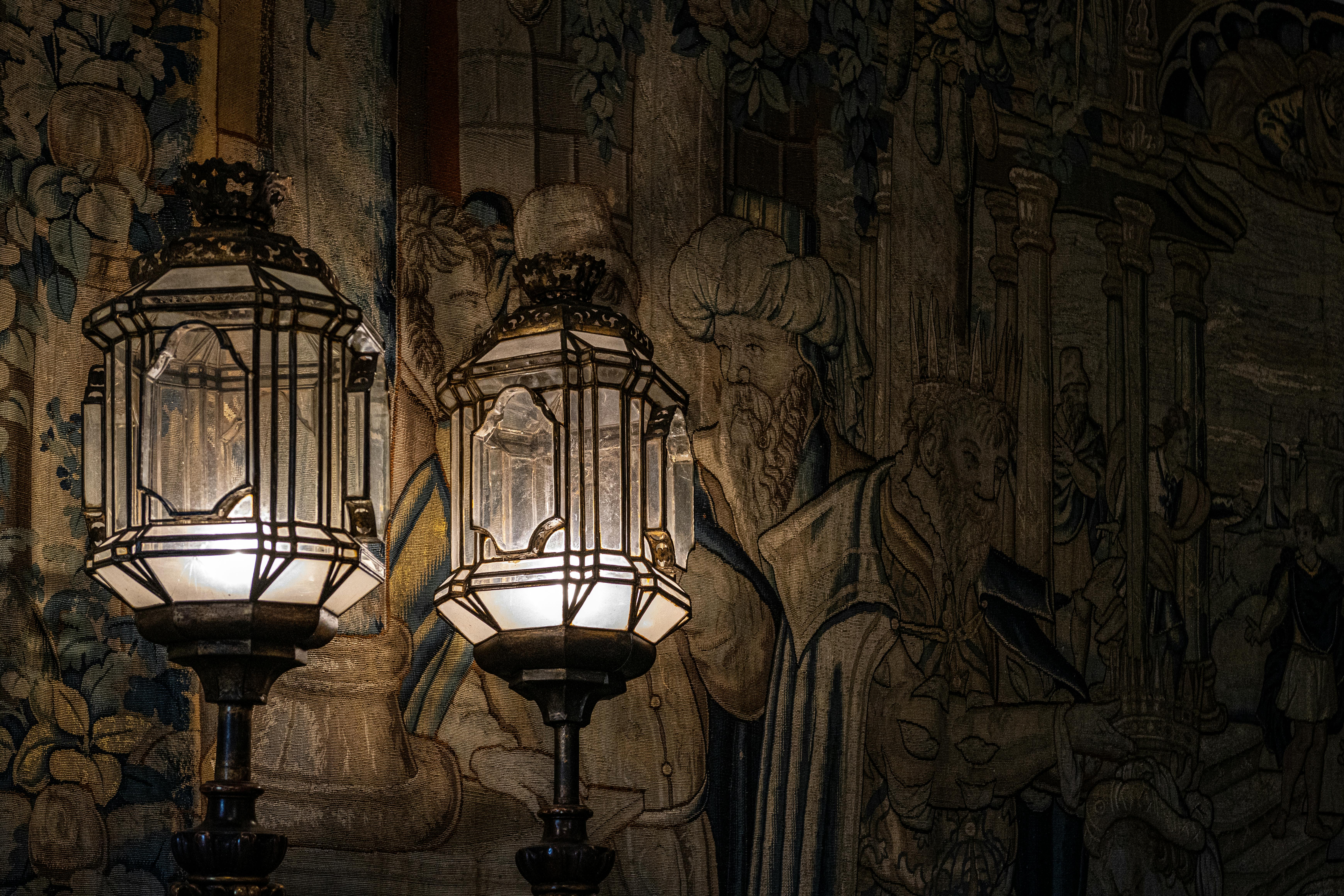 Dark Photograph of Wall with an Arras and Lanterns · Free Stock Photo