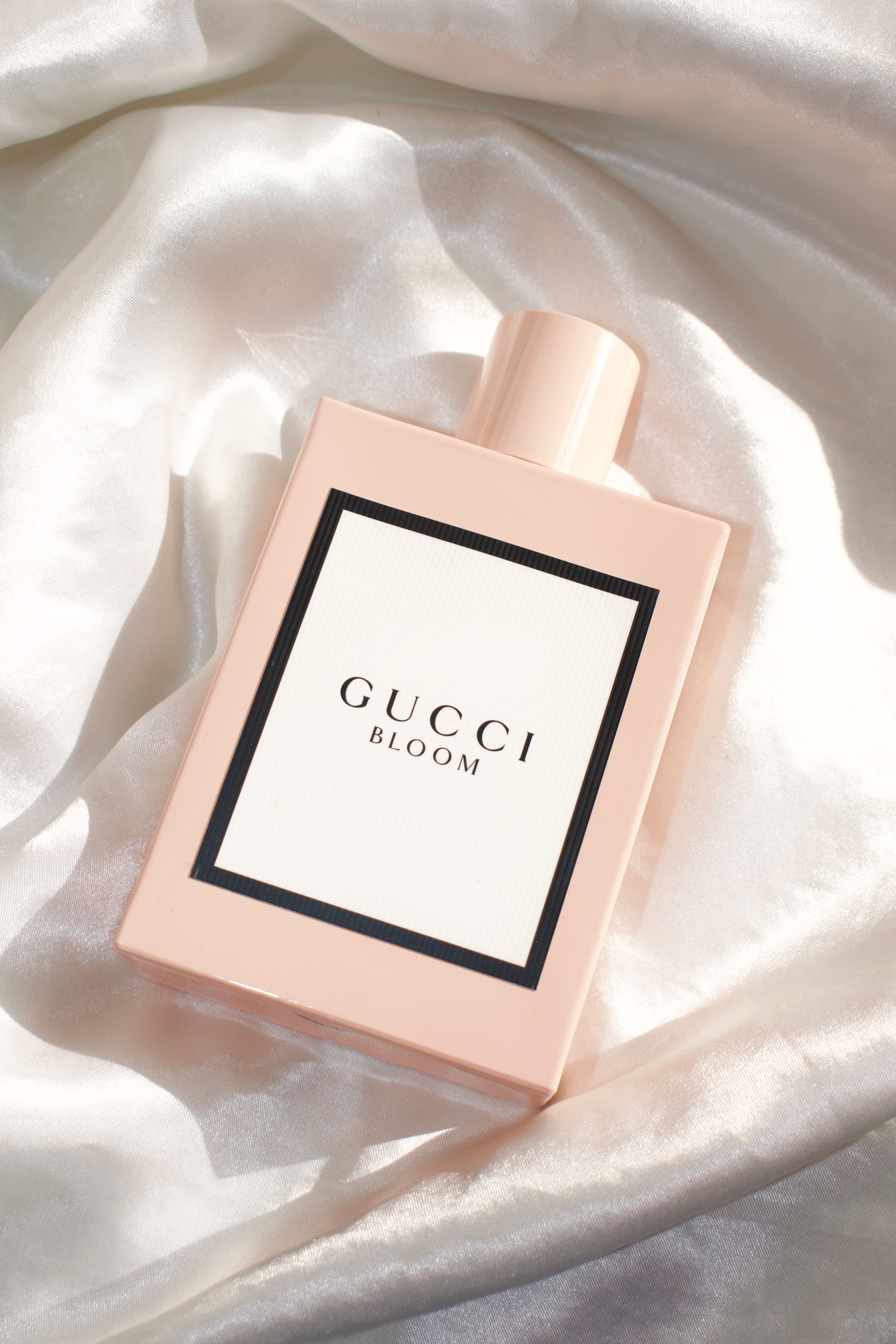 Pastel Pink Perfume Bottle on a White Silk · Free Stock Photo