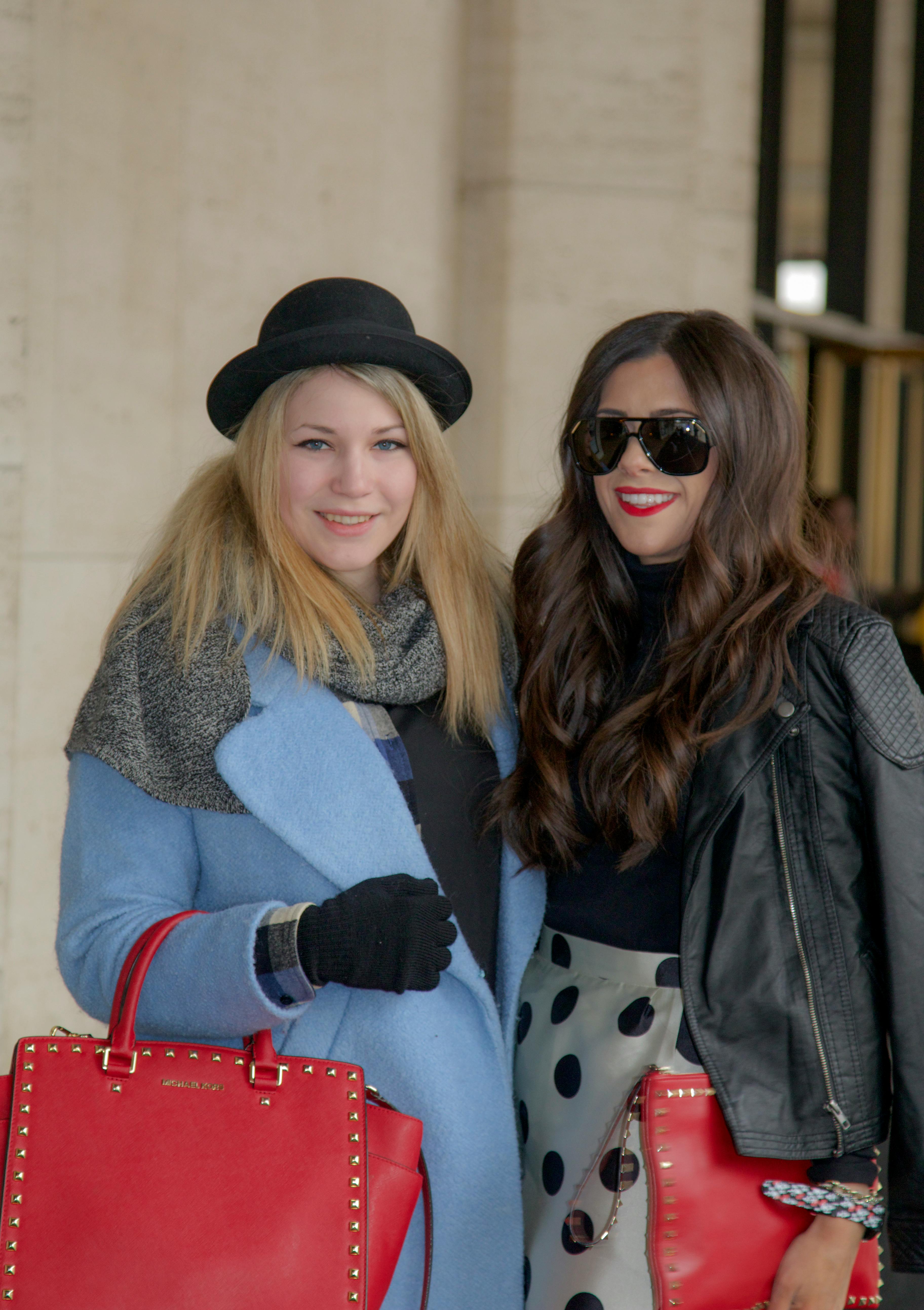Chic Duo: Two Women in Coordinating Blue Coats, Black Hats, and ...