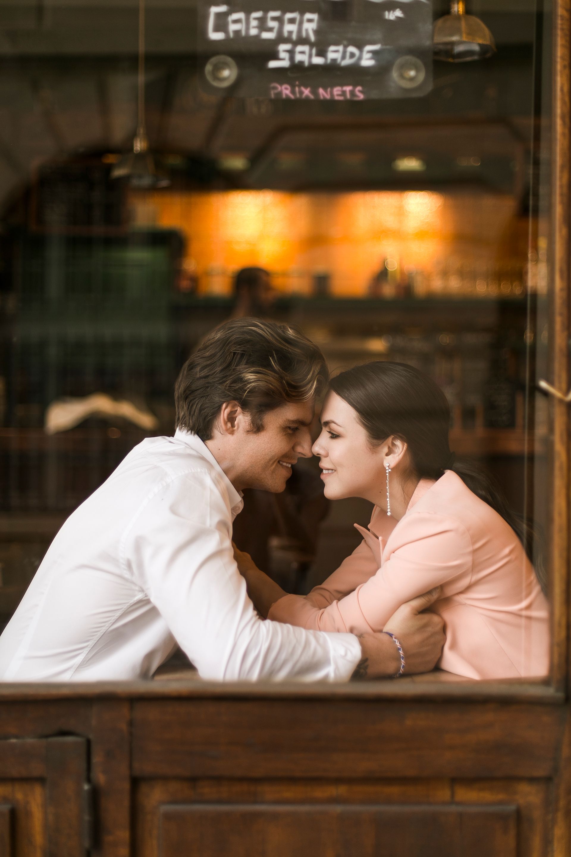 A Couple Sitting Head to Head in a Restaurant and Smiling · Free Stock ...