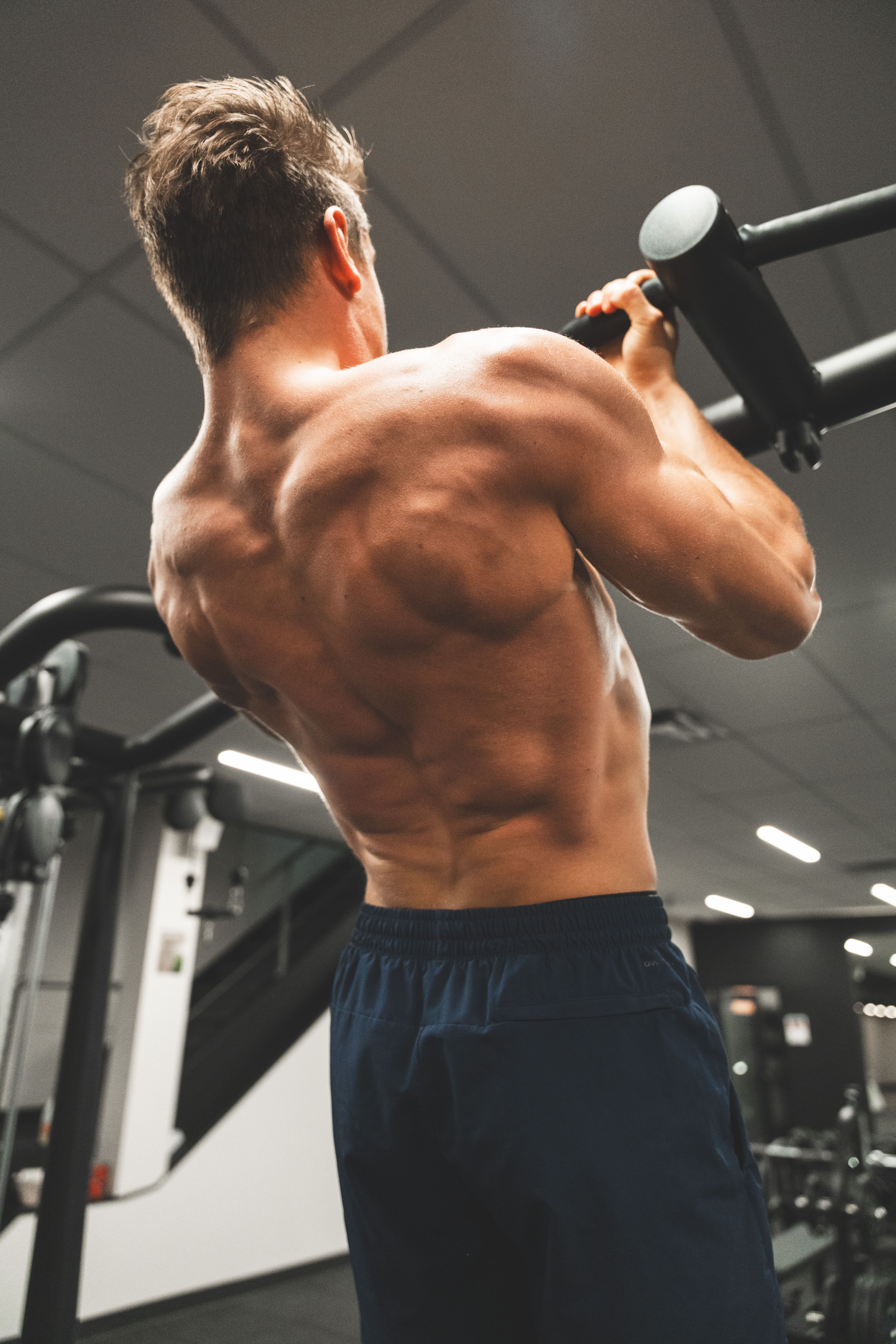 A Muscular Man Flexing His Muscles at the Gym · Free Stock Photo
