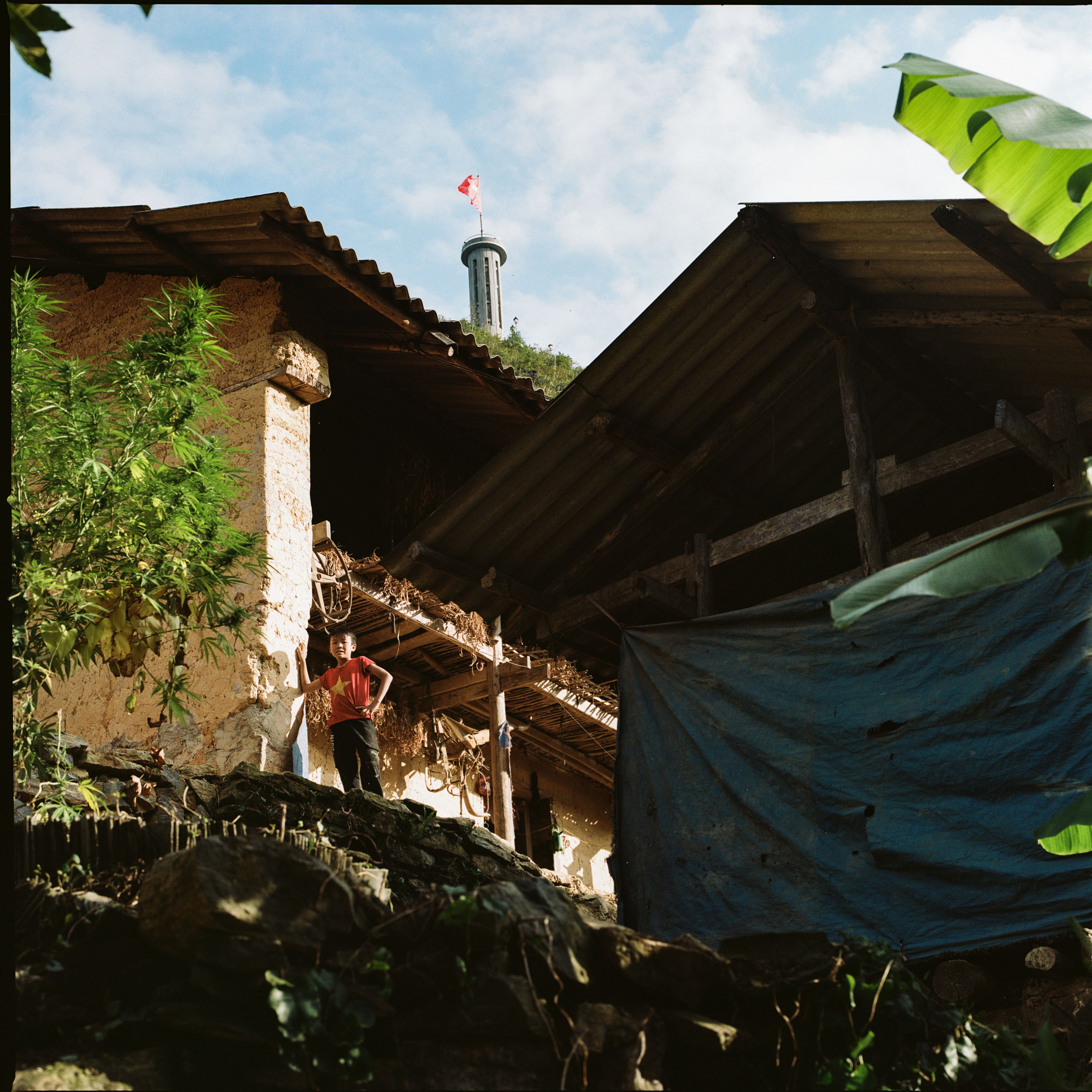 Boy Standing near Walls of Buildings in Village · Free Stock Photo