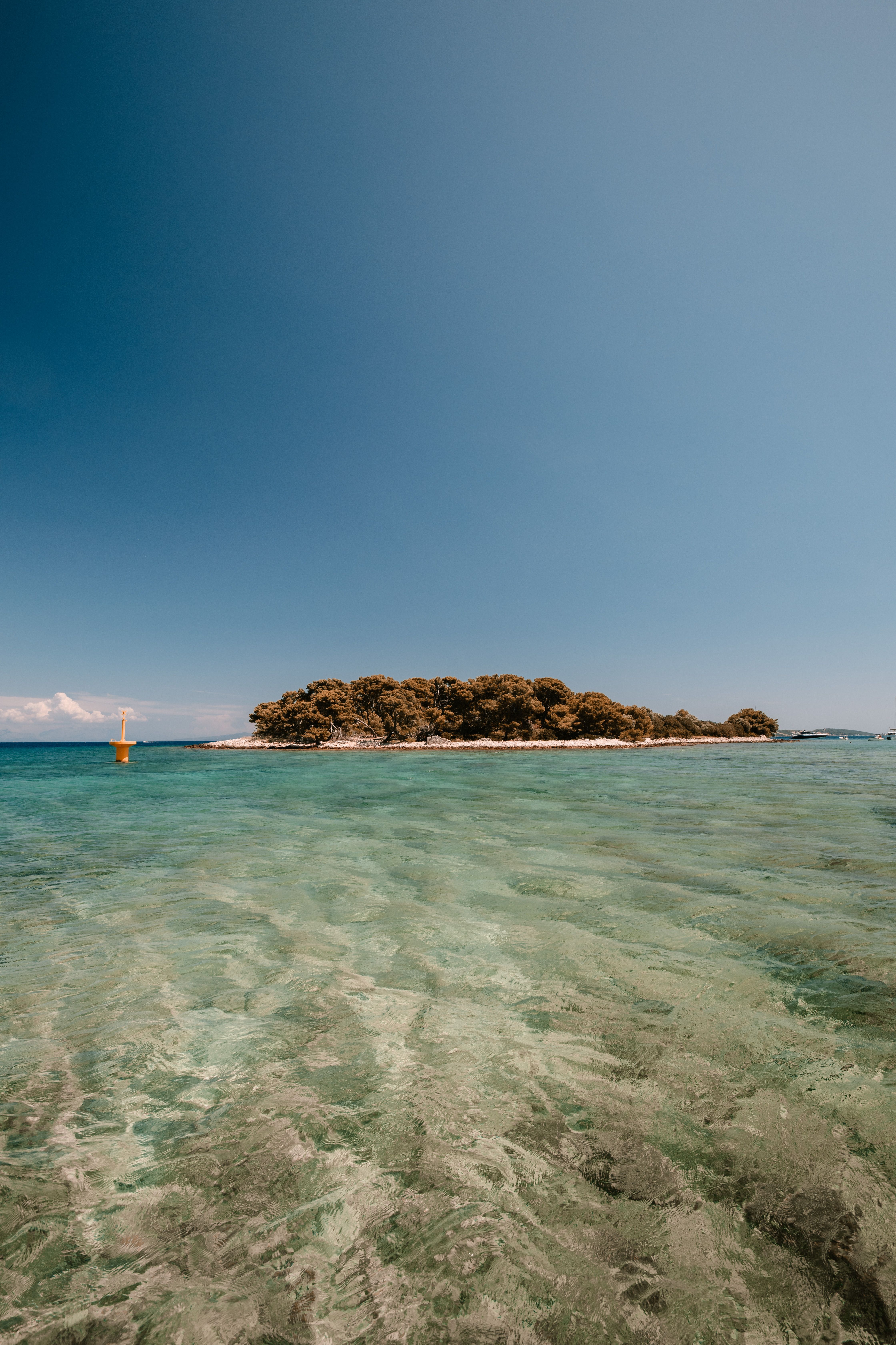 Shallow Sea Shore and Island behind · Free Stock Photo
