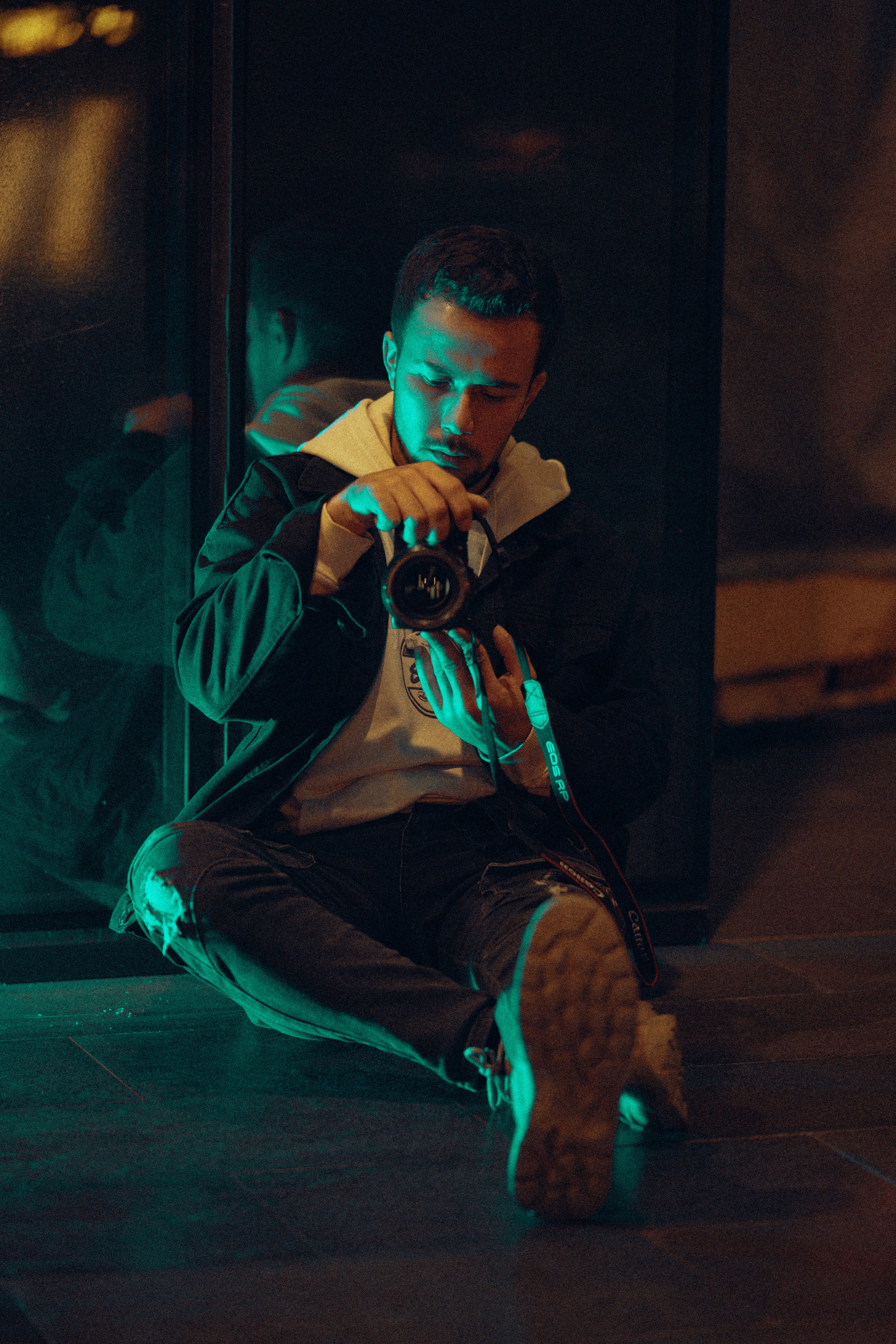 Man with Camera Sitting at Night · Free Stock Photo