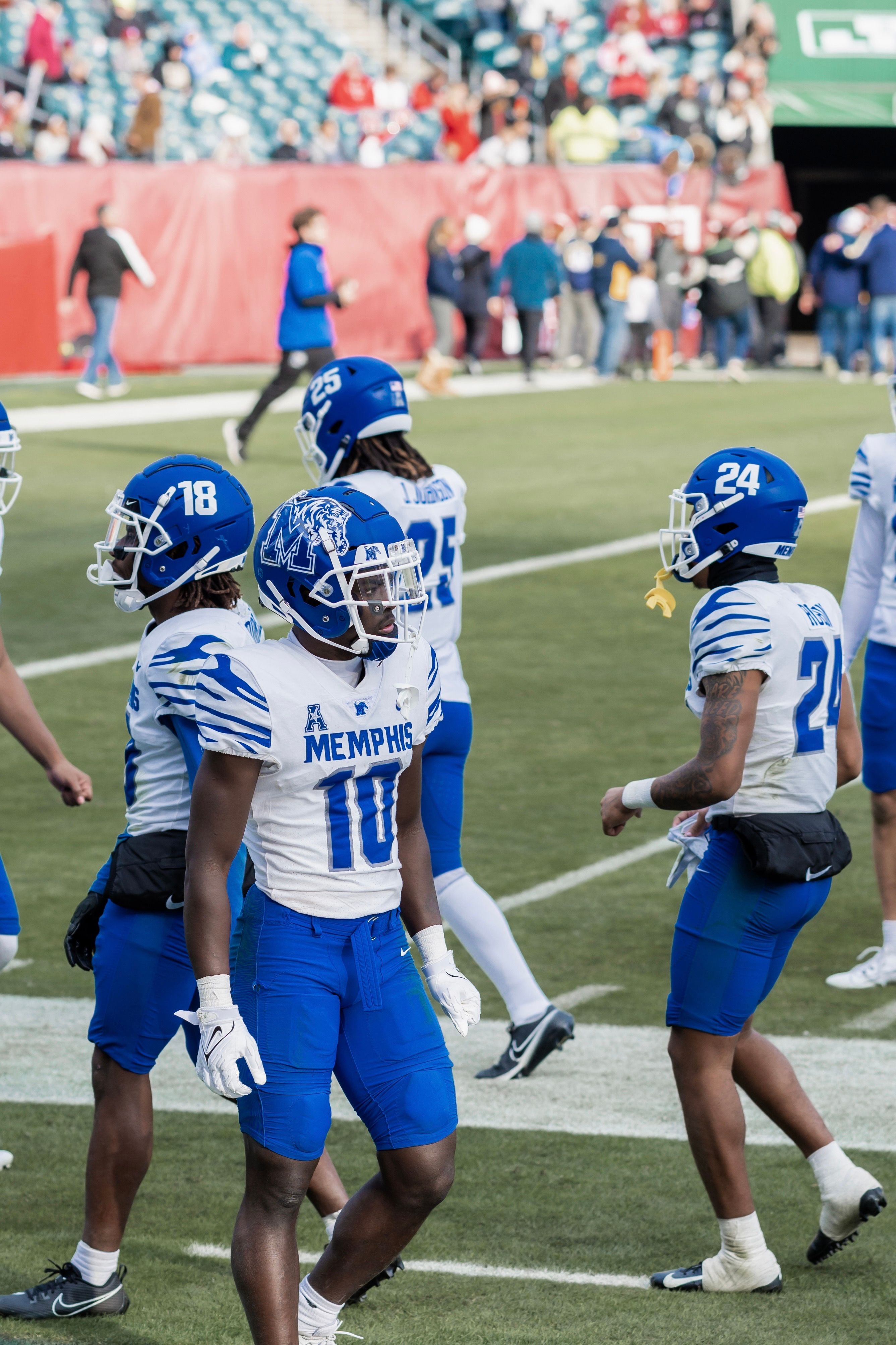 Football Team Running Thru Football Field · Free Stock Photo