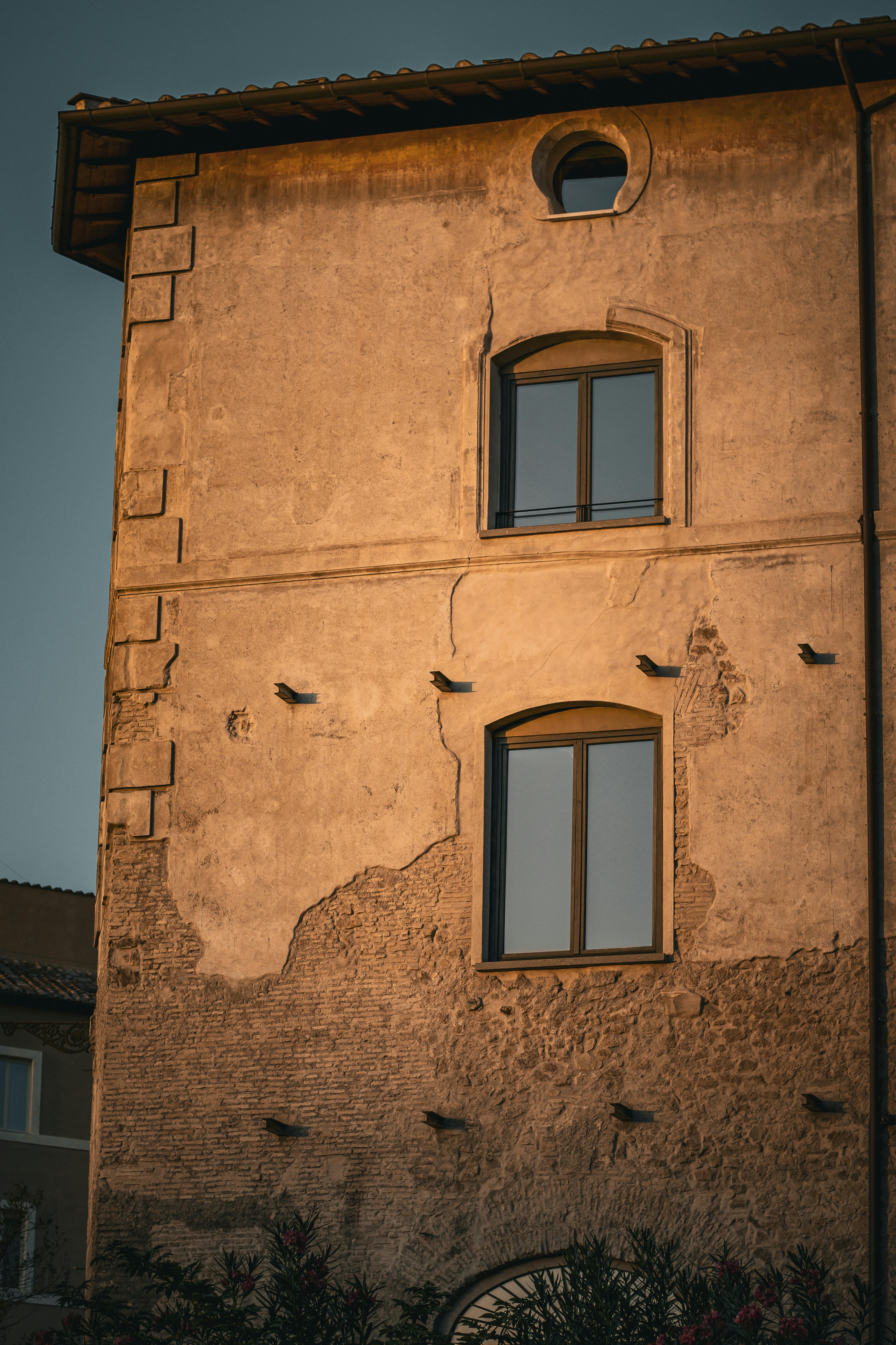Crumbling Facade of an old Tenement House in the Light of the Setting ...