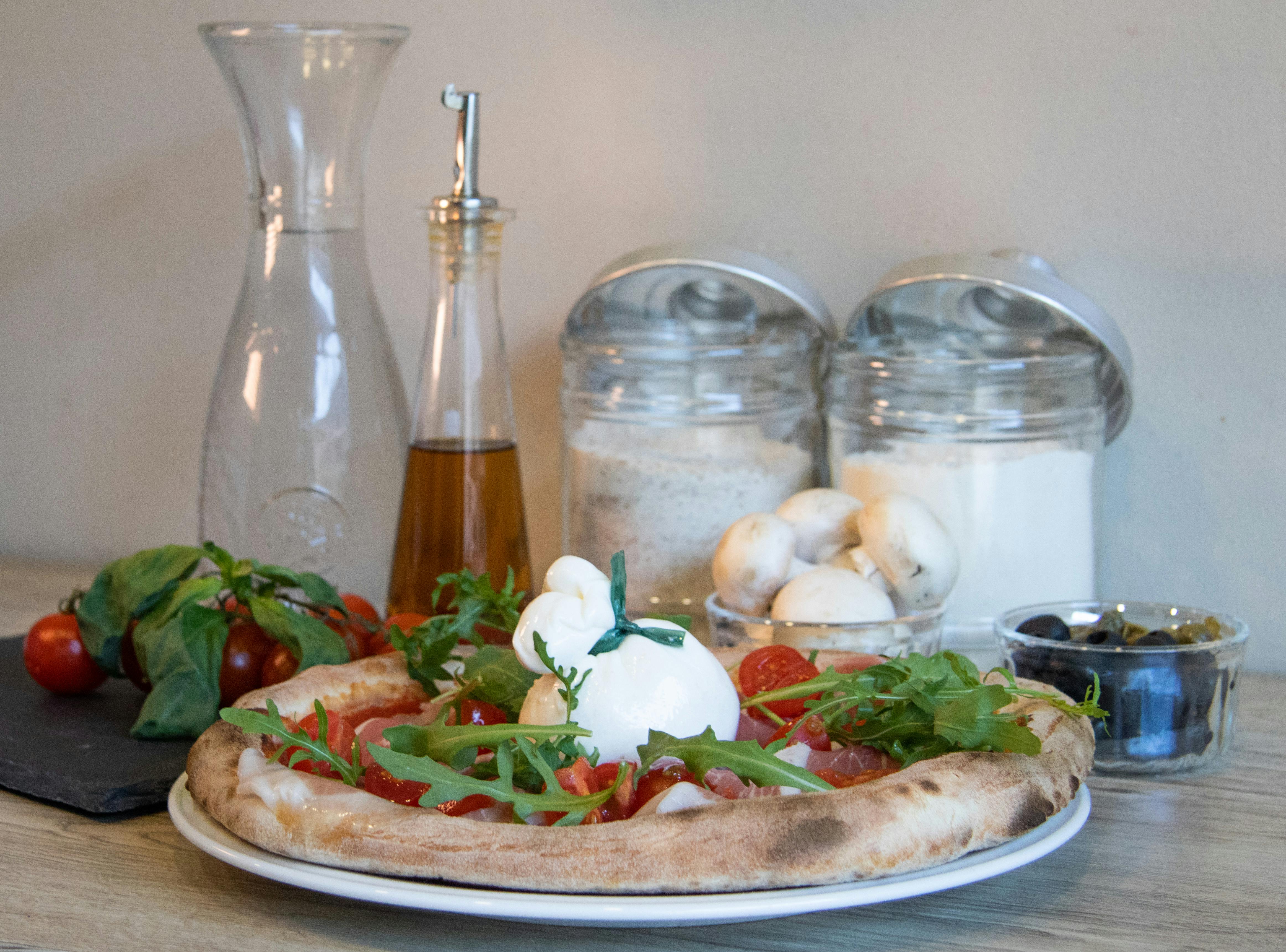 Pizza and Jars behind · Free Stock Photo