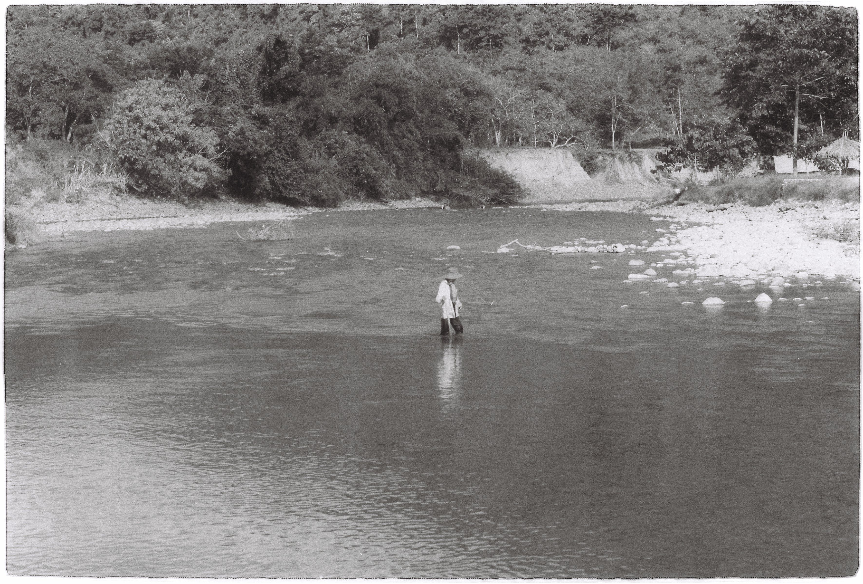 Person Walking in Shallow Lake Water · Free Stock Photo