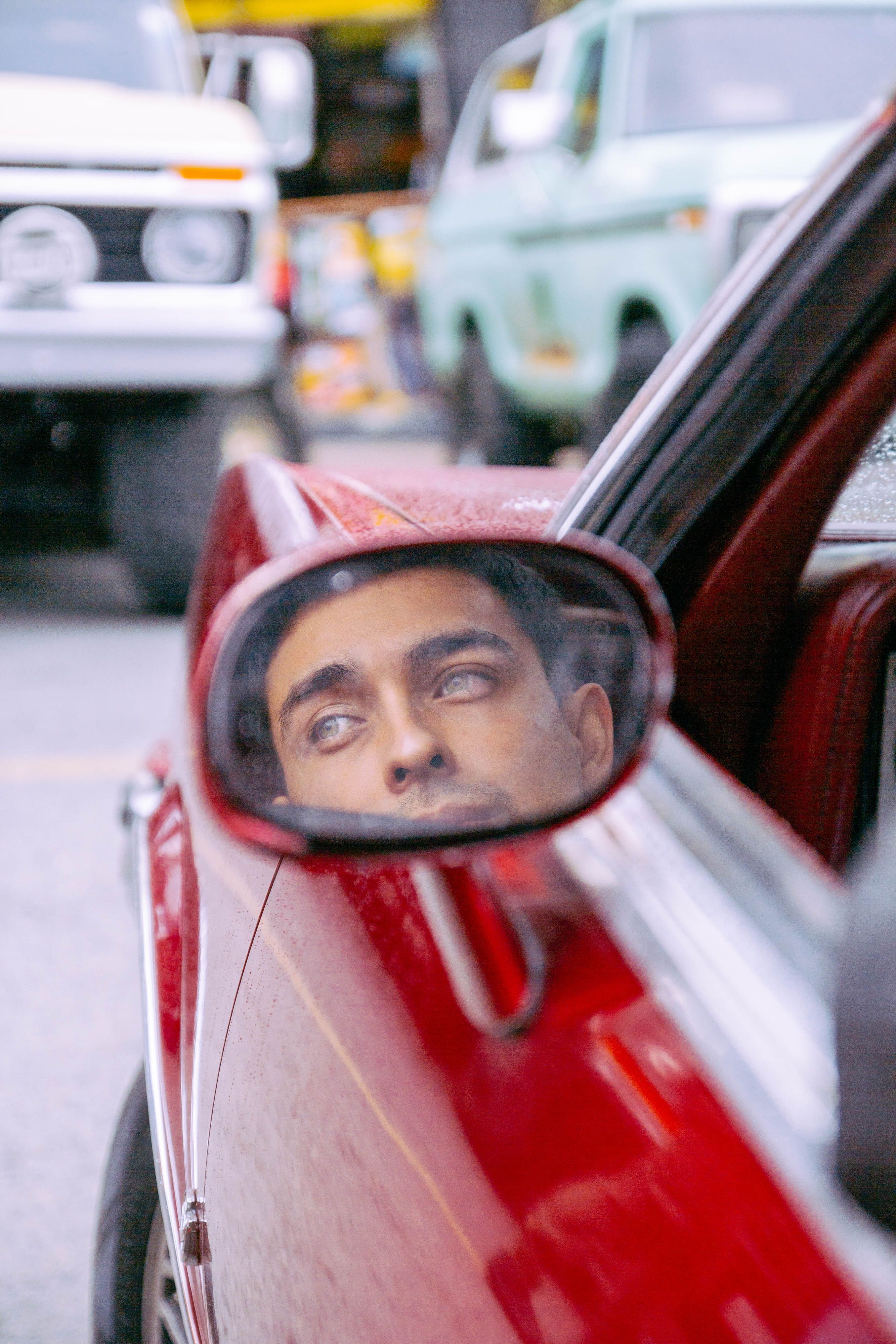Reflection of Driver in Side Mirror on Red Car · Free Stock Photo