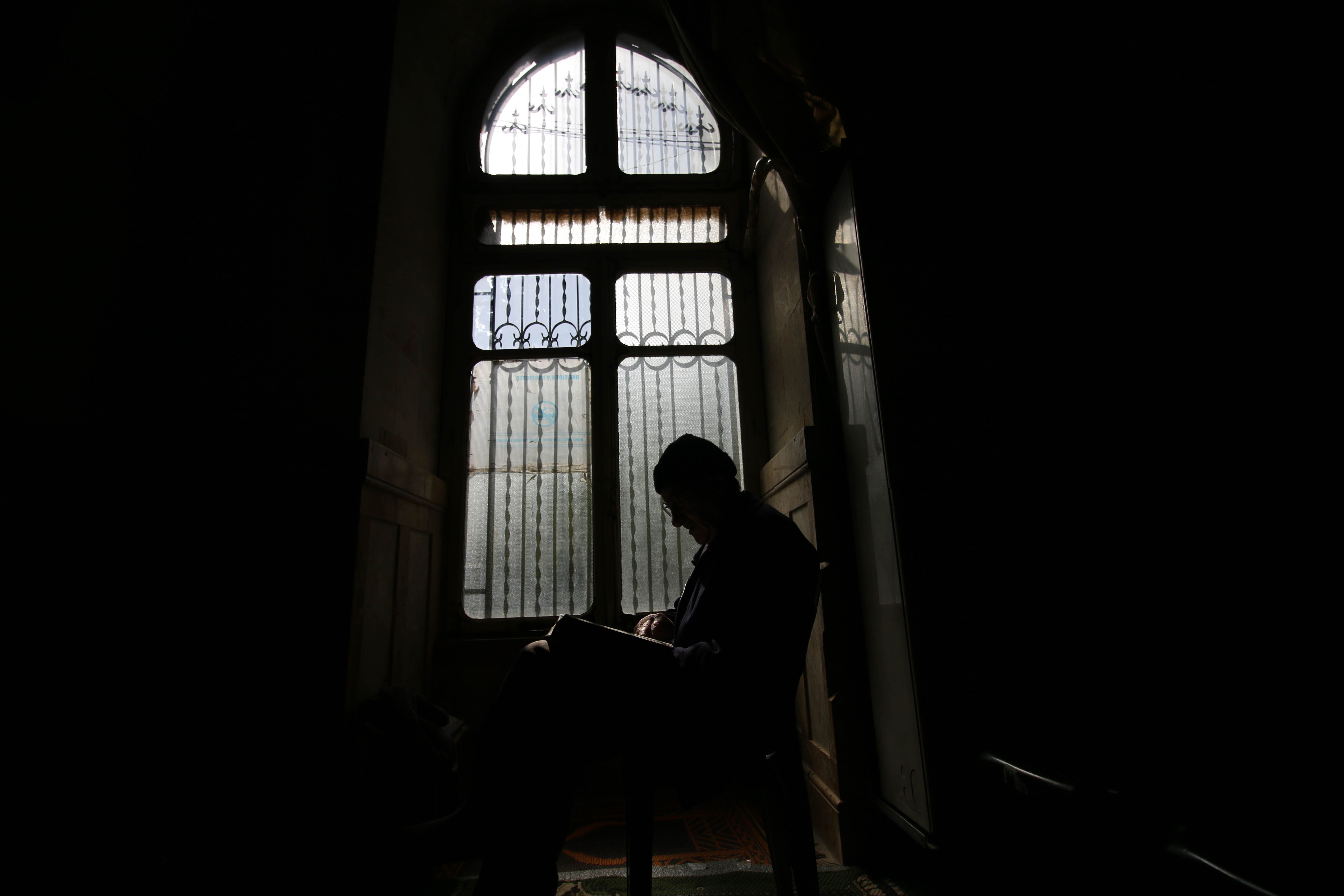 Silhouette of a Man Sitting by the Window · Free Stock Photo