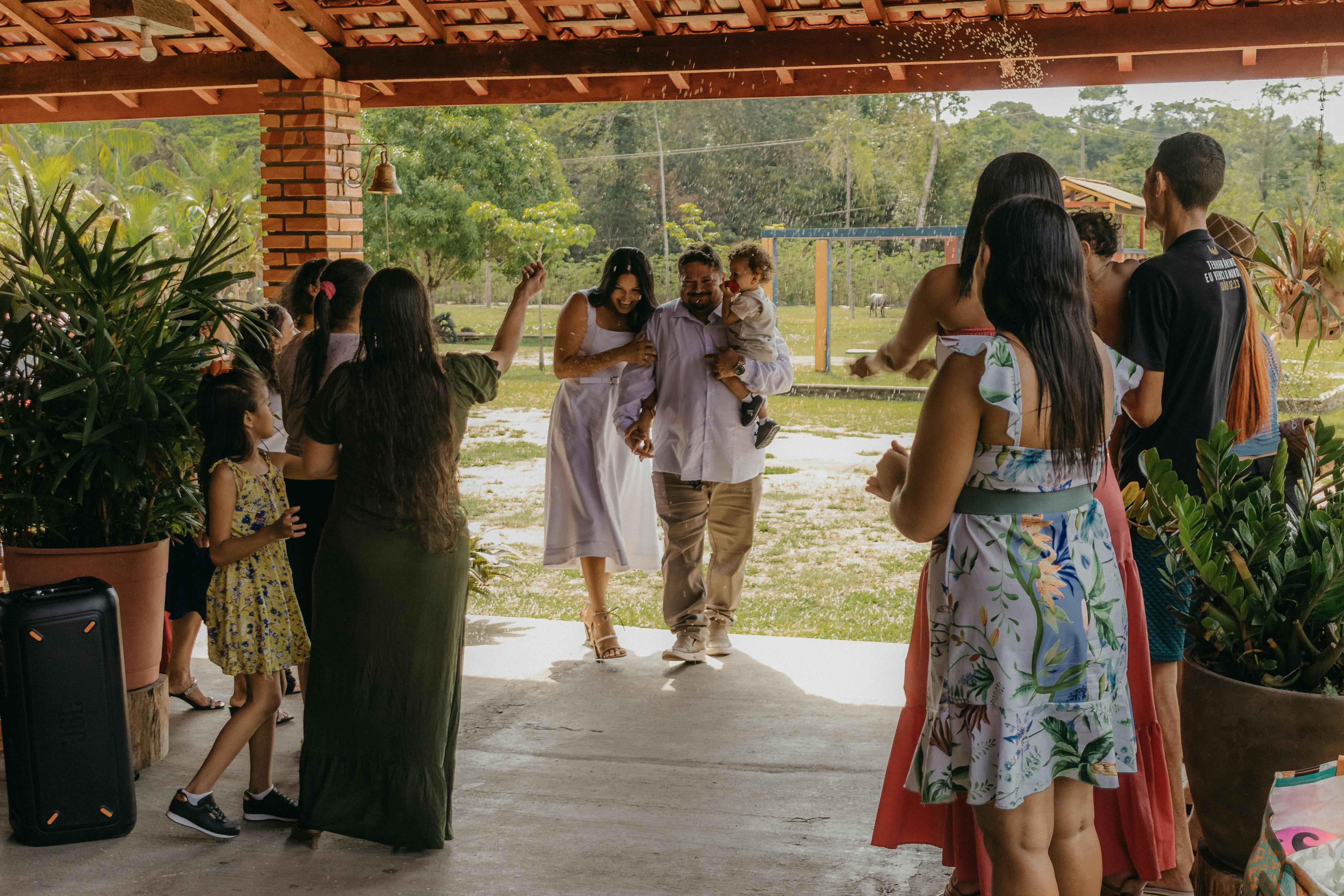 Guests Throwing Rice on Newlywed Couple · Free Stock Photo
