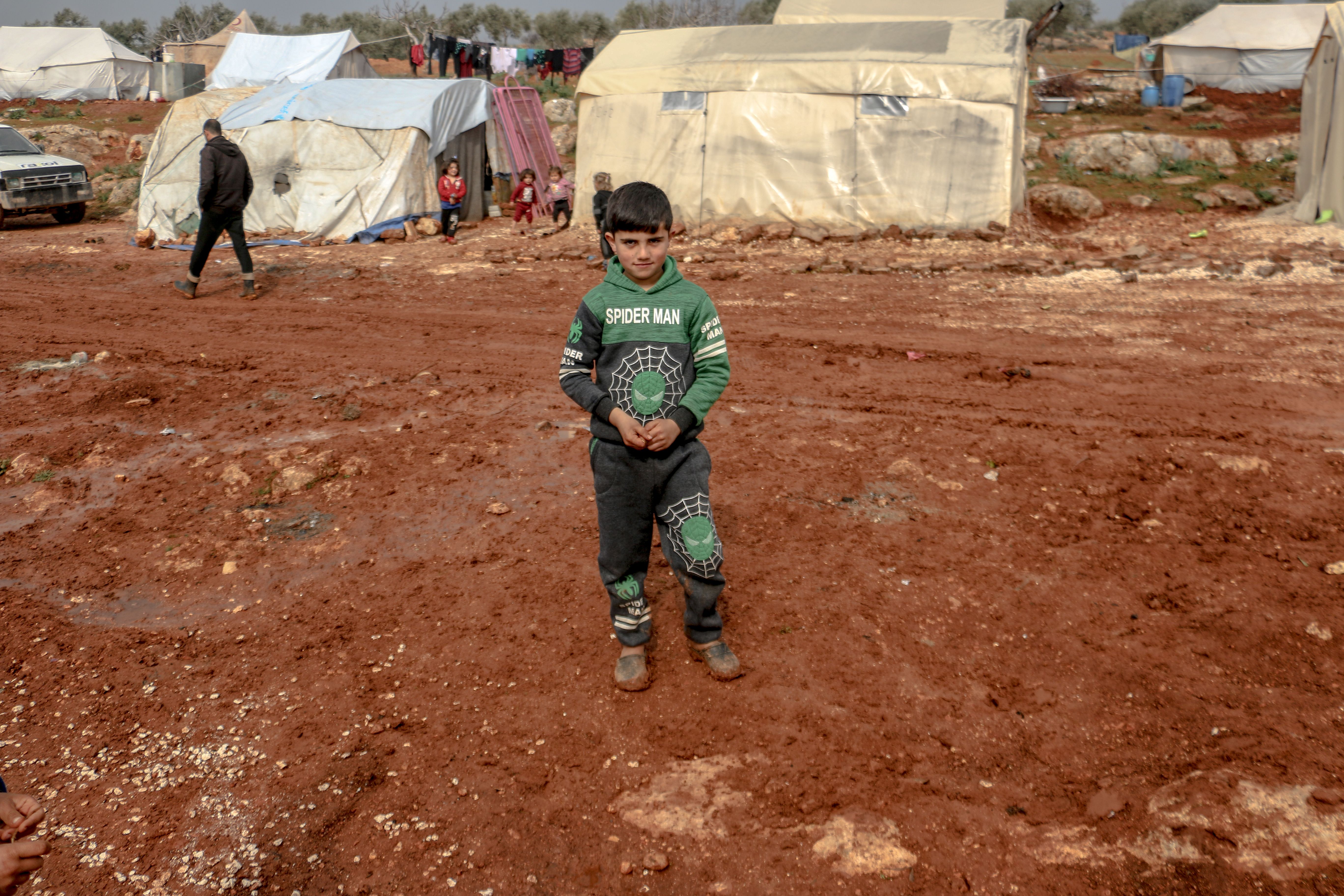 A Little Boy Standing at a Refugee Campsite · Free Stock Photo
