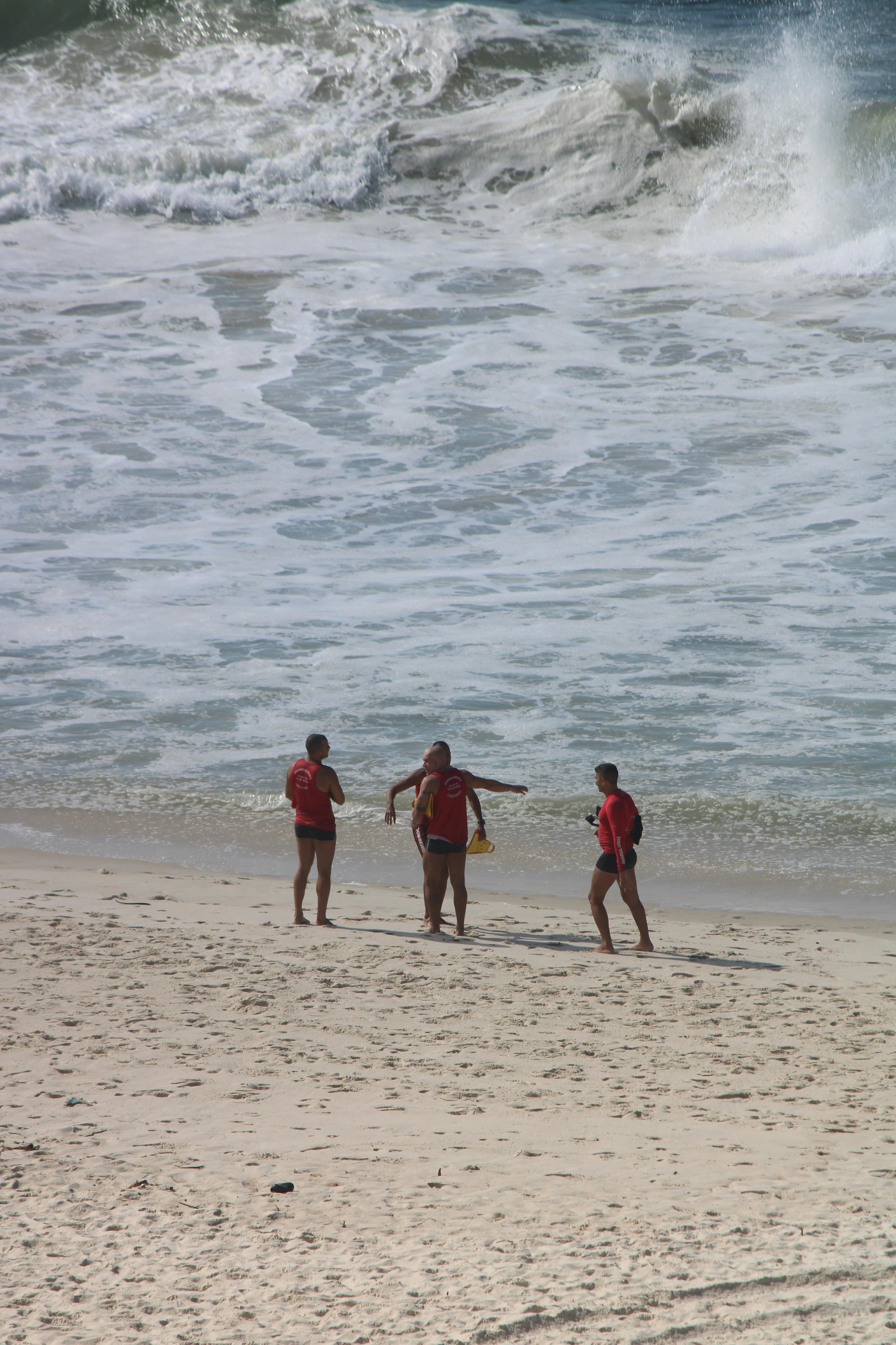 Aerial View of a Group of Lifeguards Standing on a Beach · Free Stock Photo