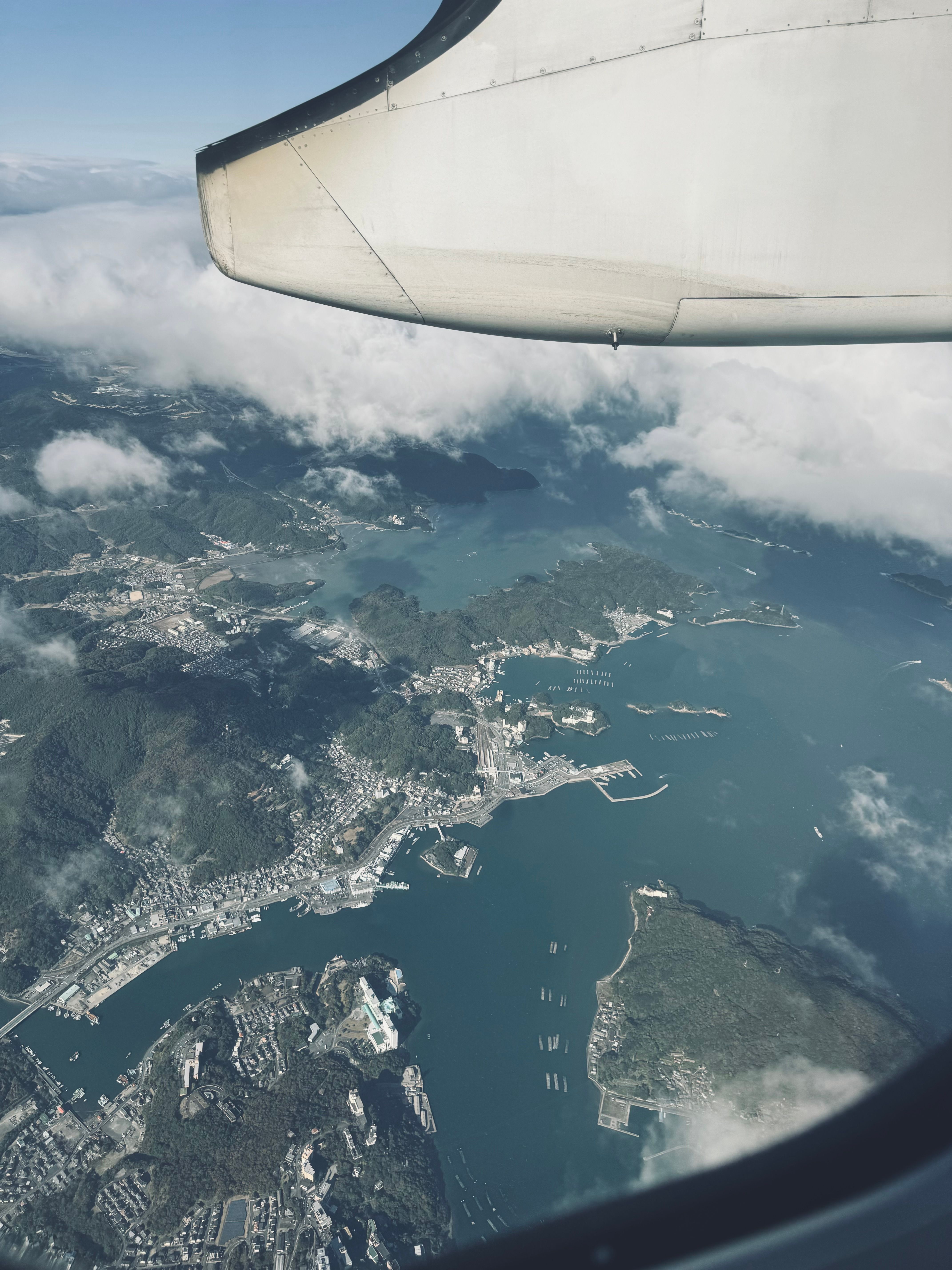 Town and Sea Coast under Airplane Wing · Free Stock Photo