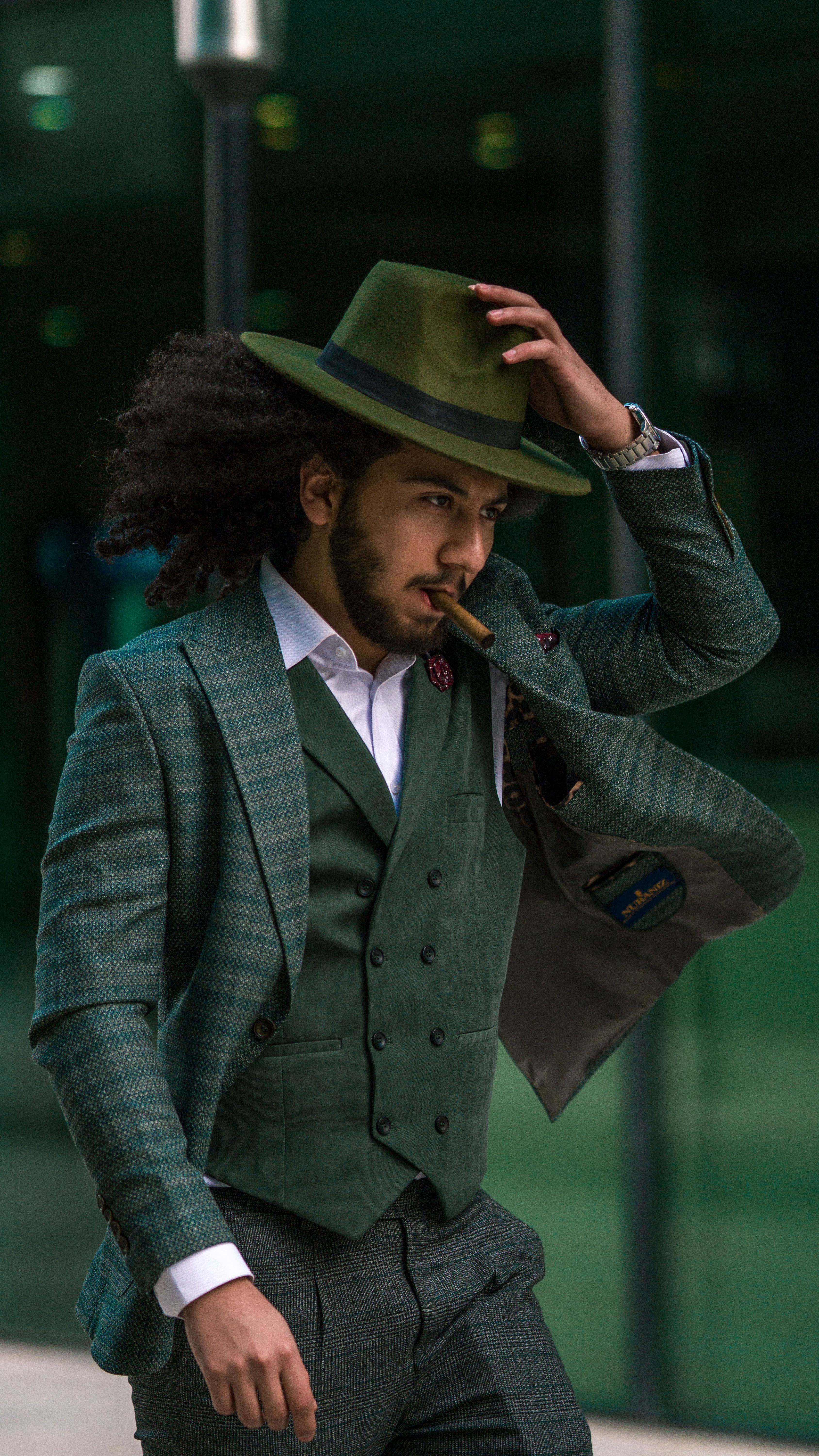 Man in a Suit and Hat Walking with a Cigar in His Mouth · Free Stock Photo