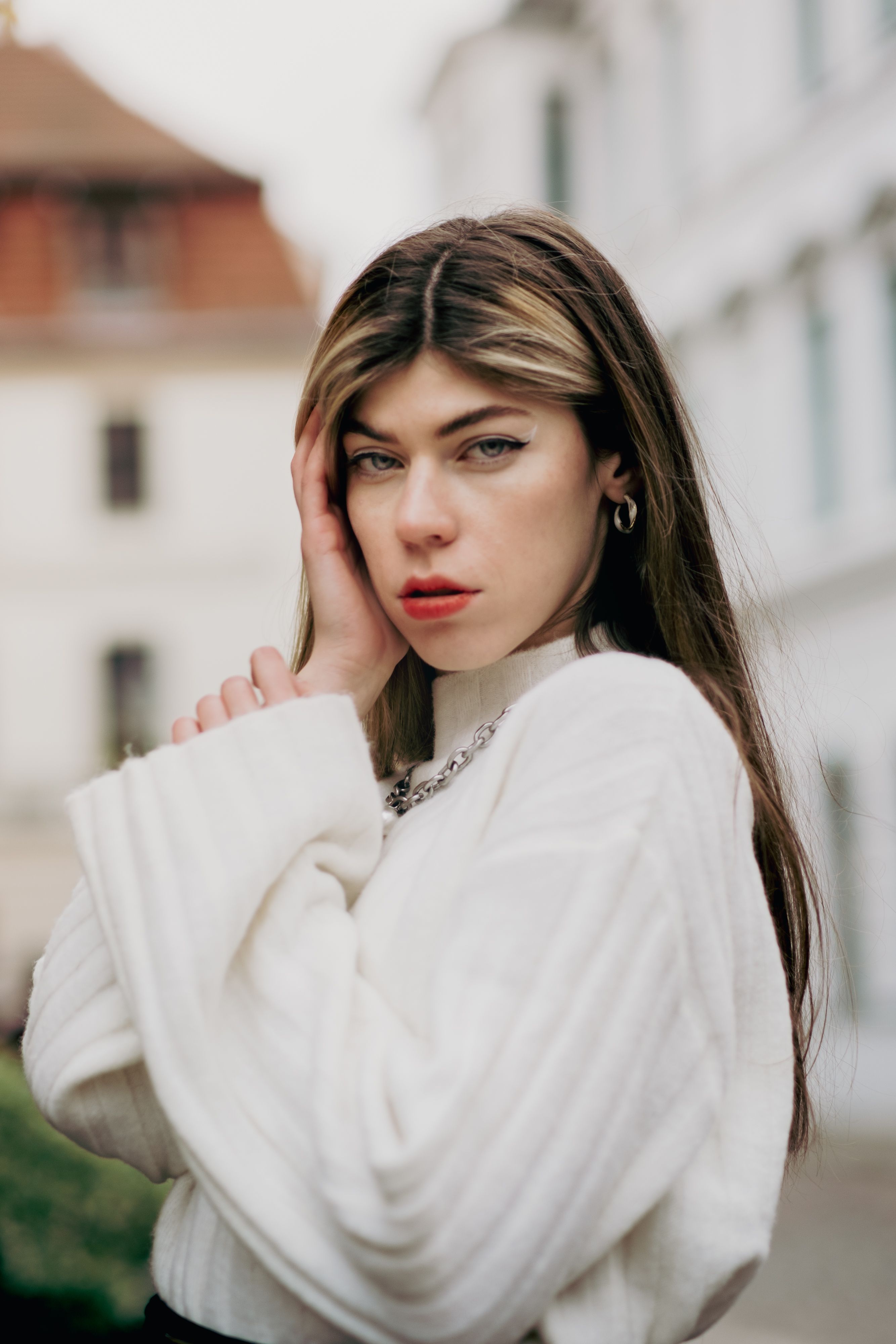 Model Wearing a White Sweater, Posing in a Town · Free Stock Photo