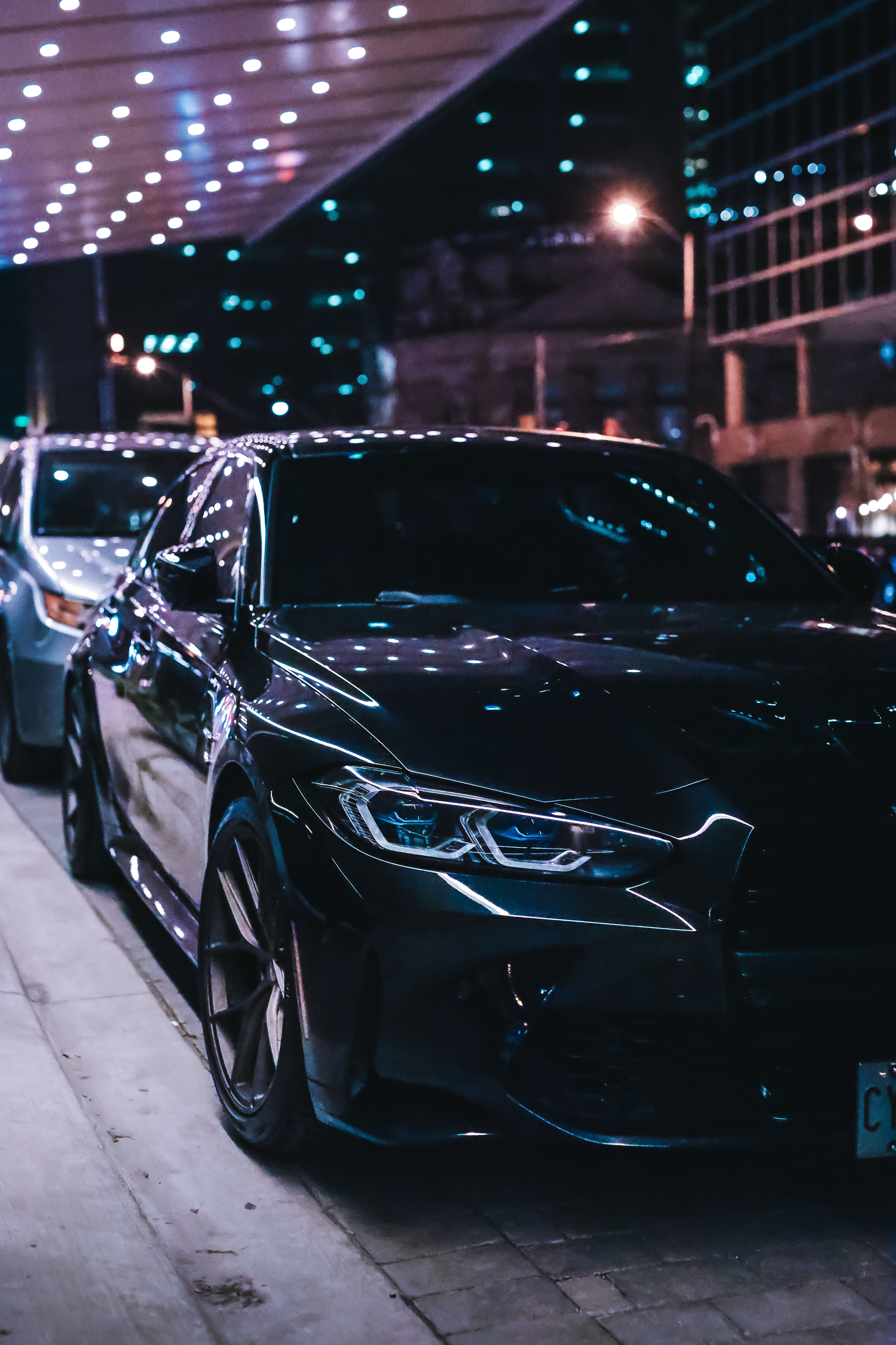 A Blue BMW M5 Parked on a Street at Night · Free Stock Photo