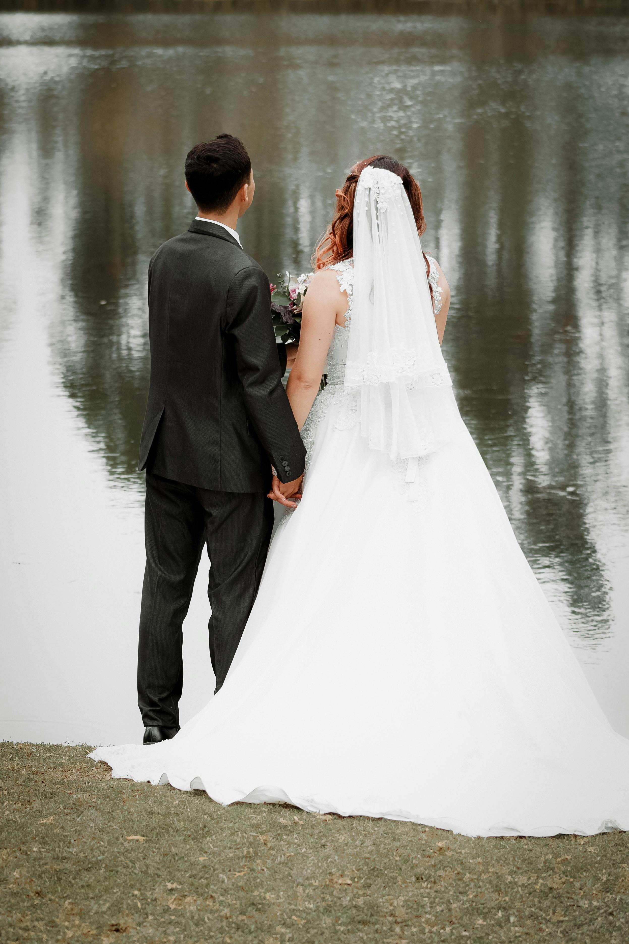 Just Married Couple Reflected in Lake · Free Stock Photo