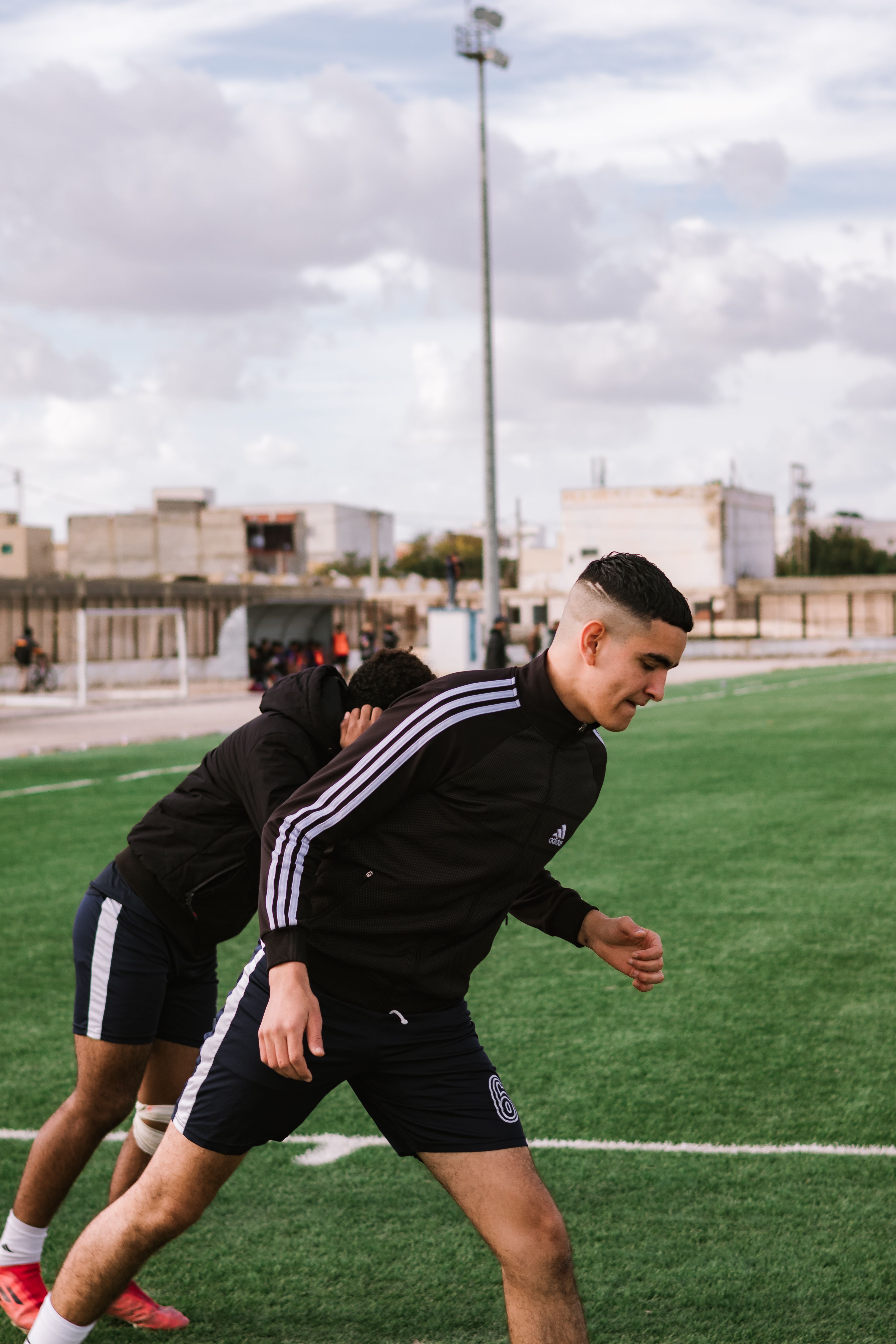 Soccer Players Stretching on the Pitch · Free Stock Photo