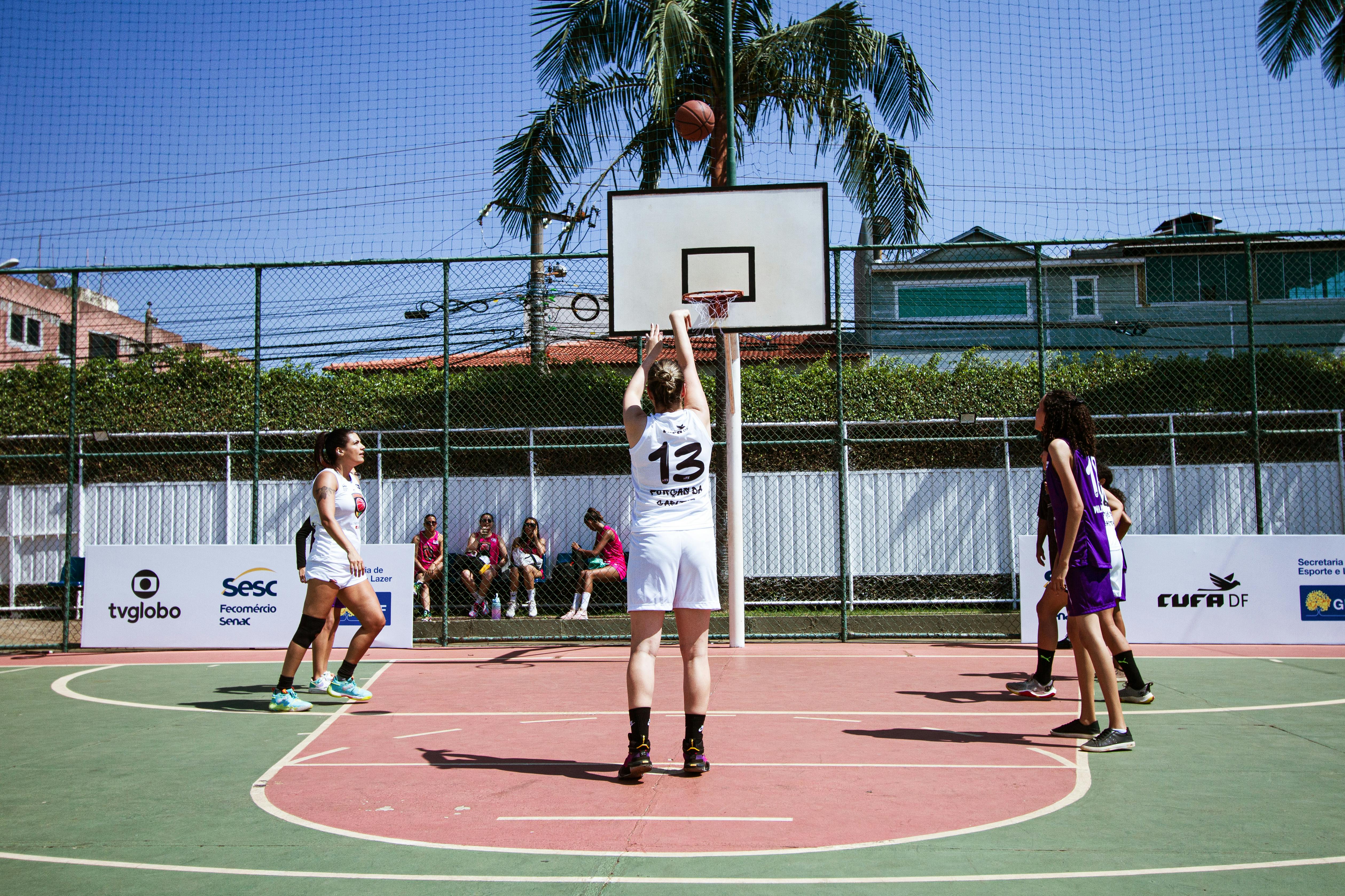 Basketball player throwing ball into basketball hoop · Free Stock Photo