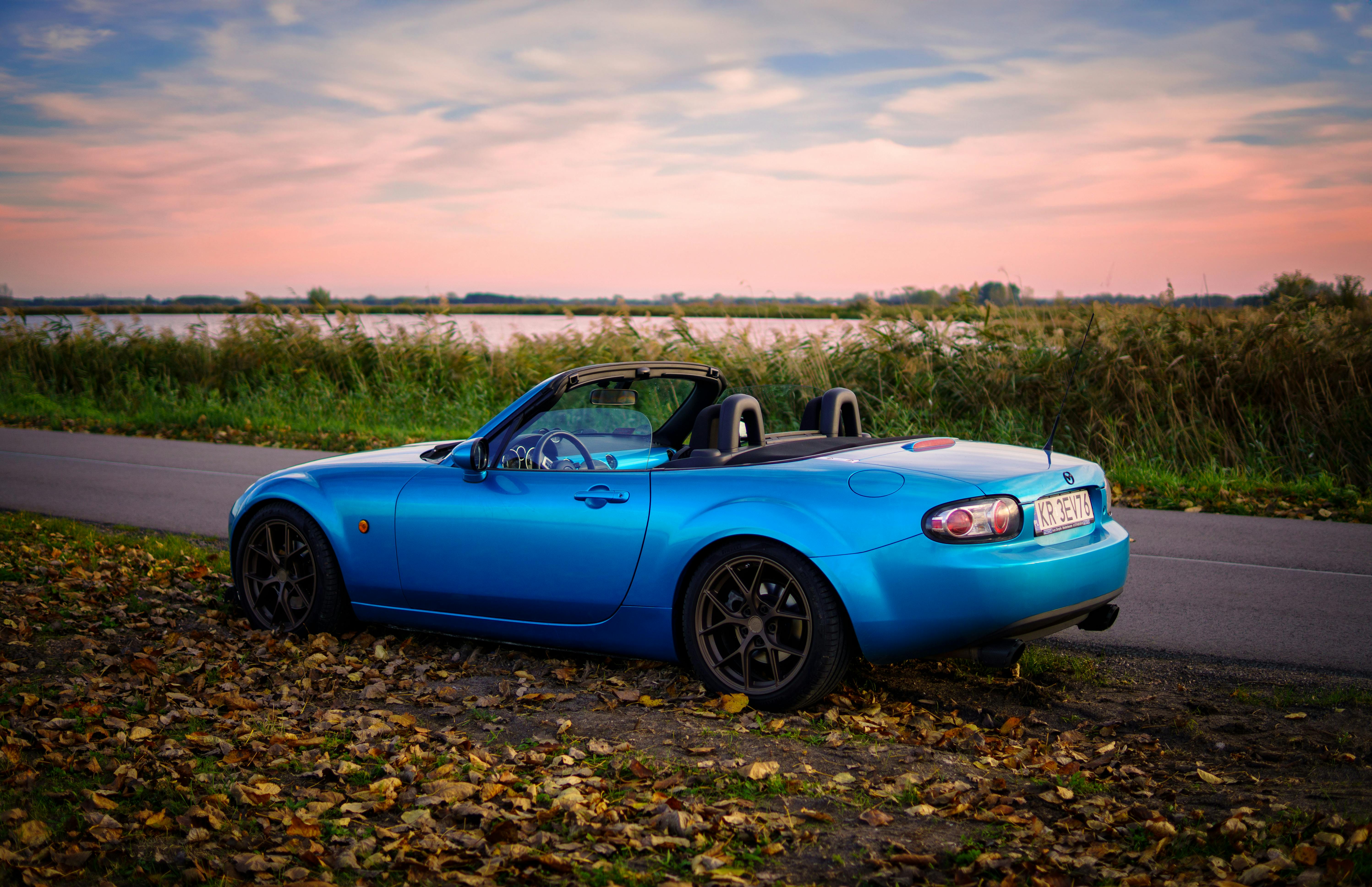 Blue Mazda MX-5 on Road at Dusk · Free Stock Photo
