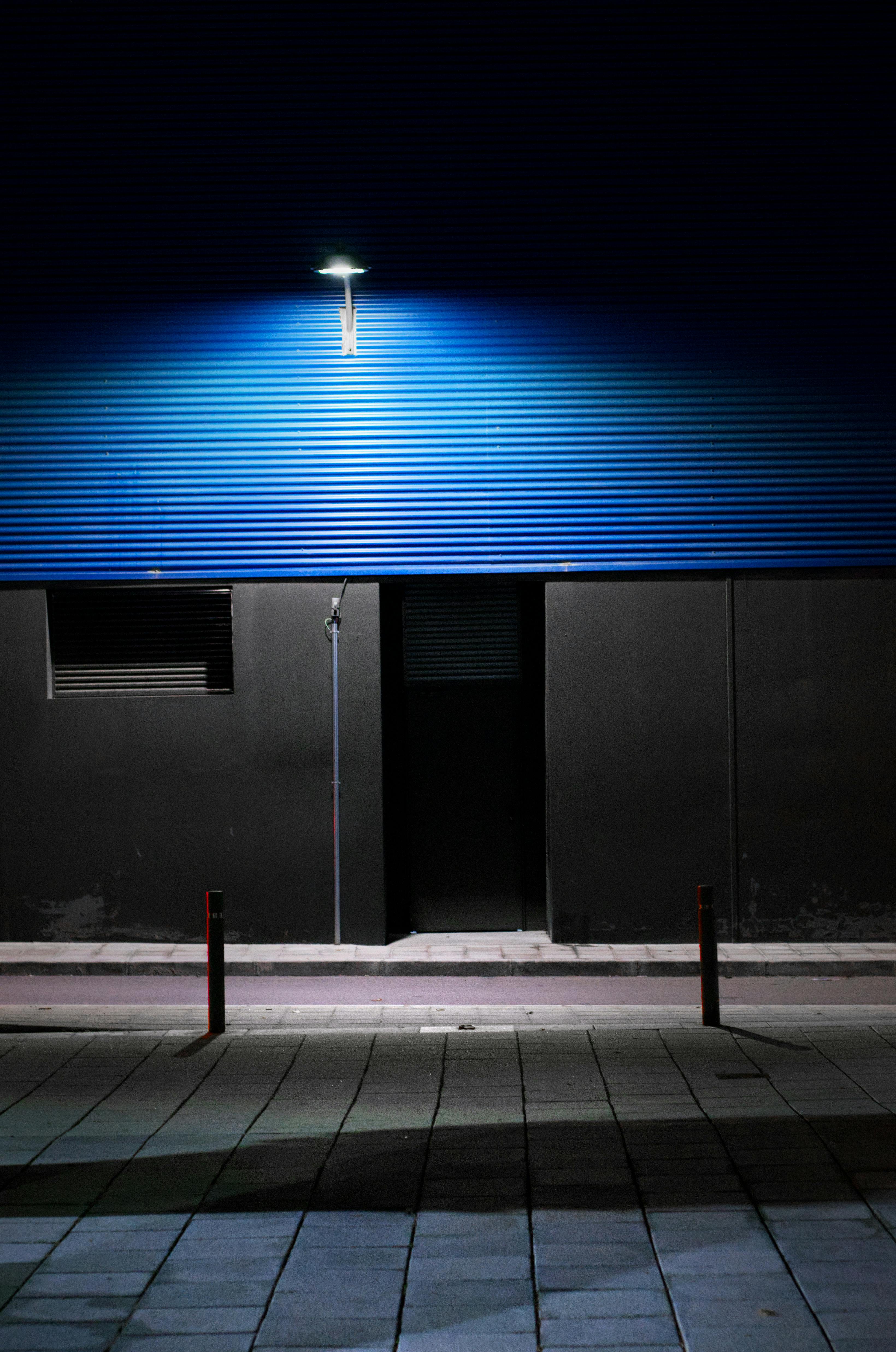 Blue and Gray Wall of a Building on a Night City Street · Free Stock Photo