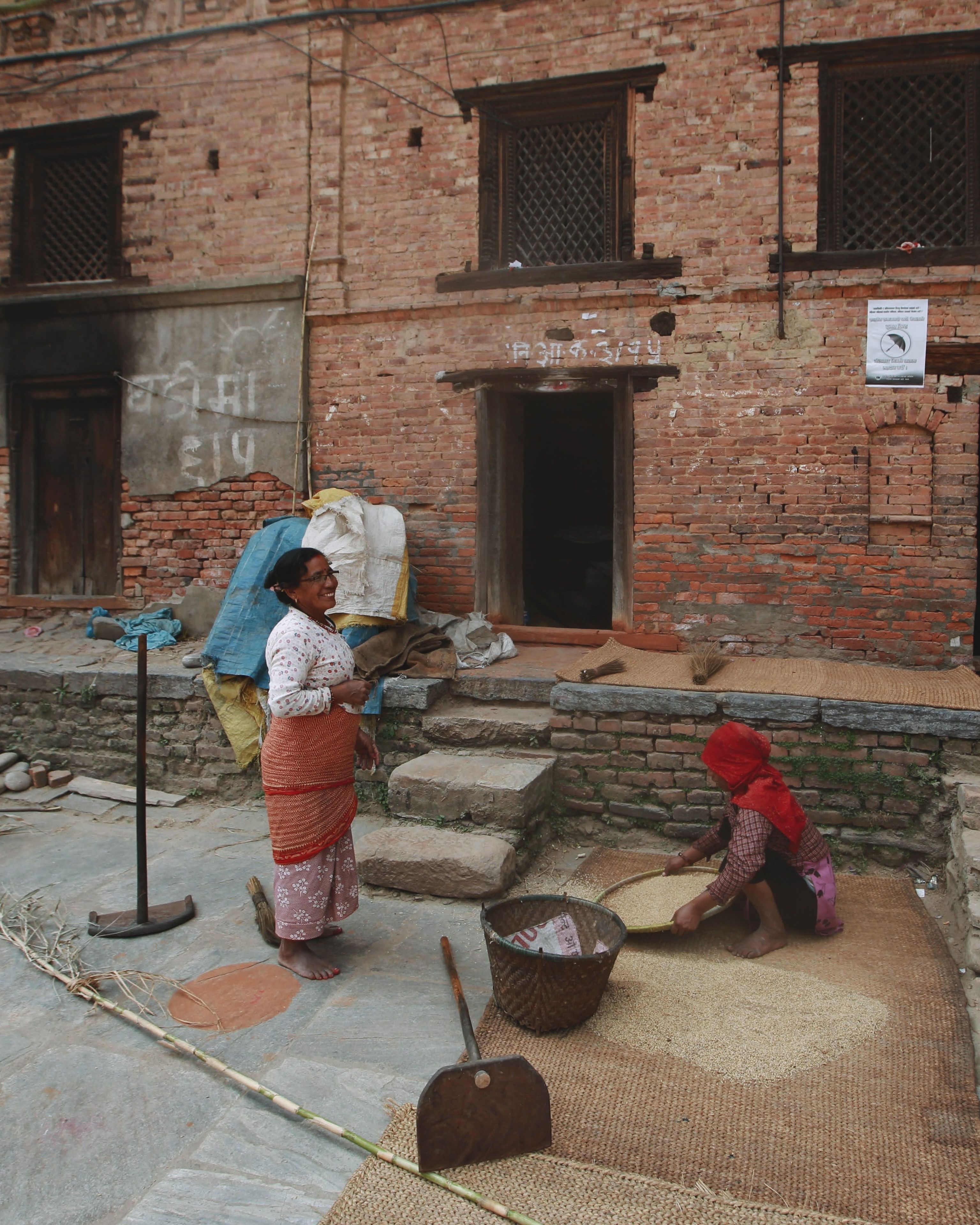 People Wearing Traditional Clothing Sifting Grain on a Yard · Free ...