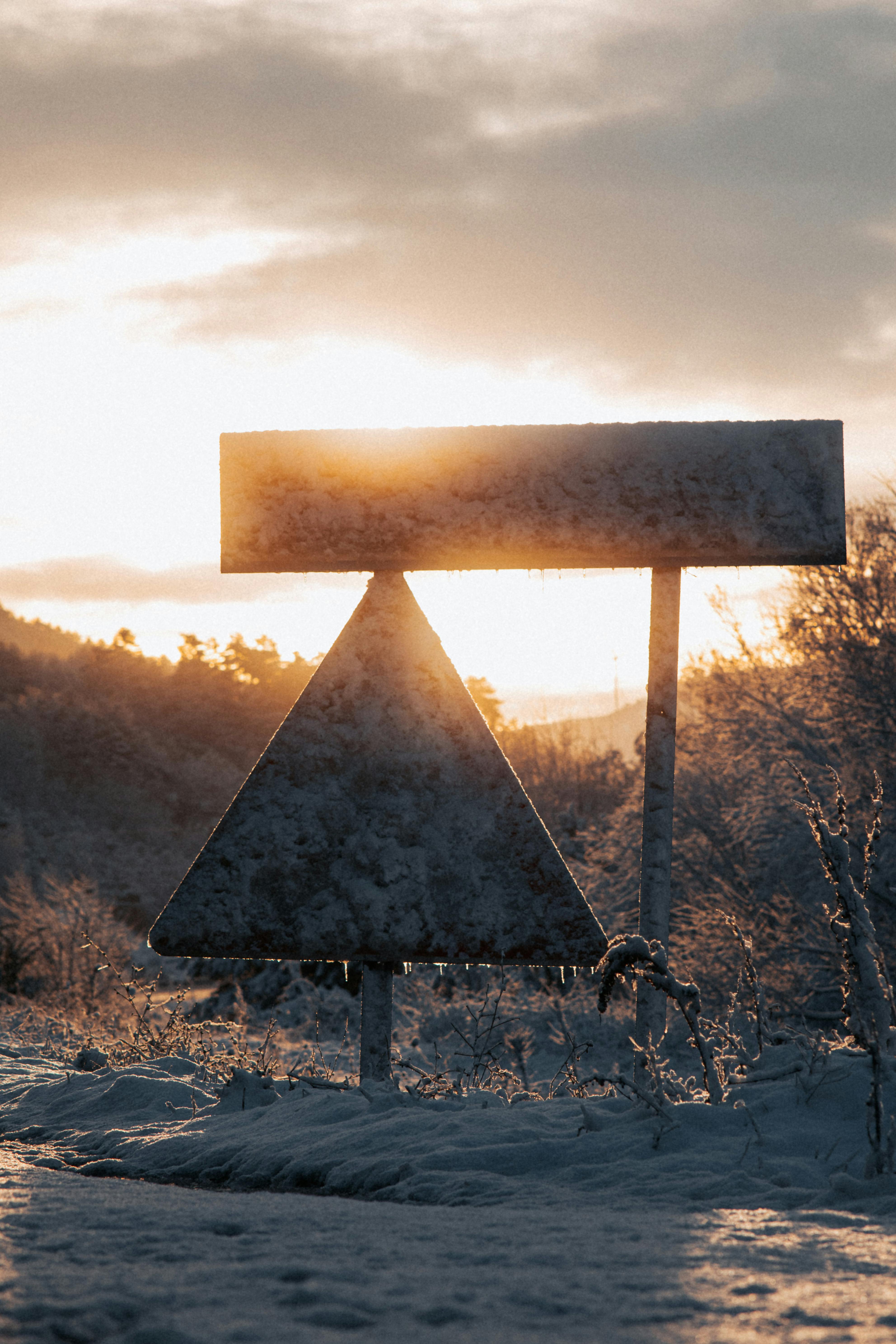 Snow Covered and Frozen Road Signs at Sunrise · Free Stock Photo