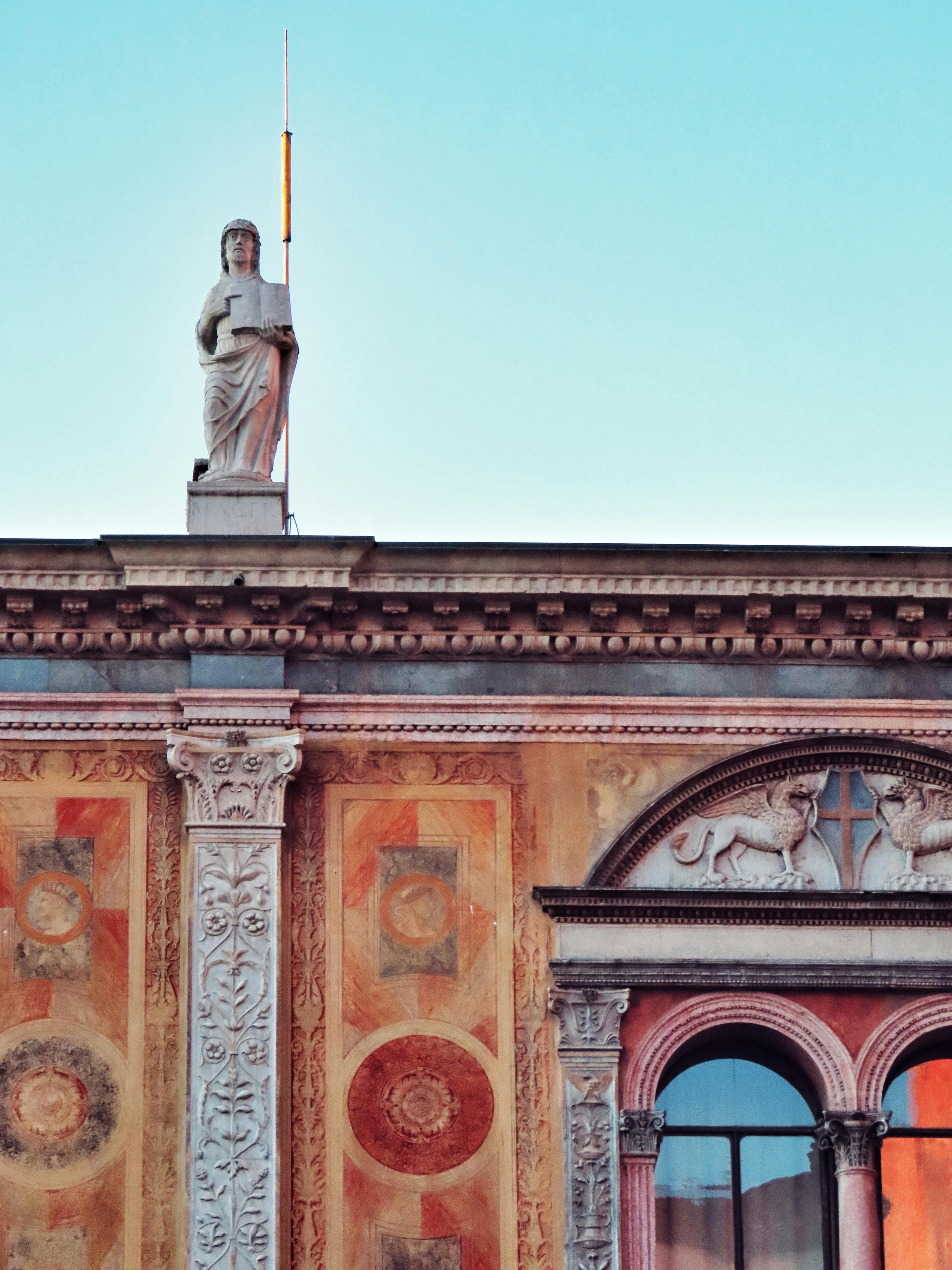 Statue on Roof of Ornamented Building · Free Stock Photo