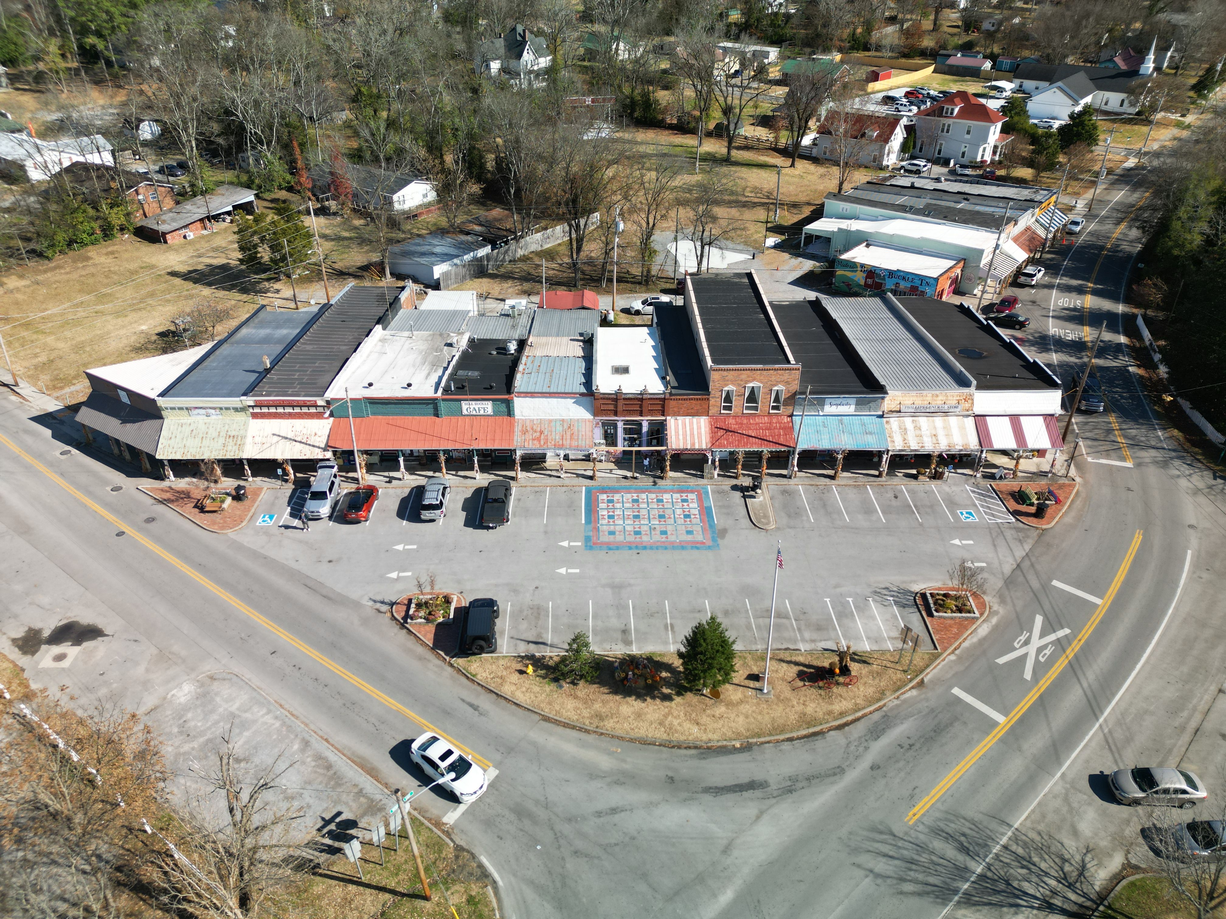 Parking Lot by Buildings in Town · Free Stock Photo