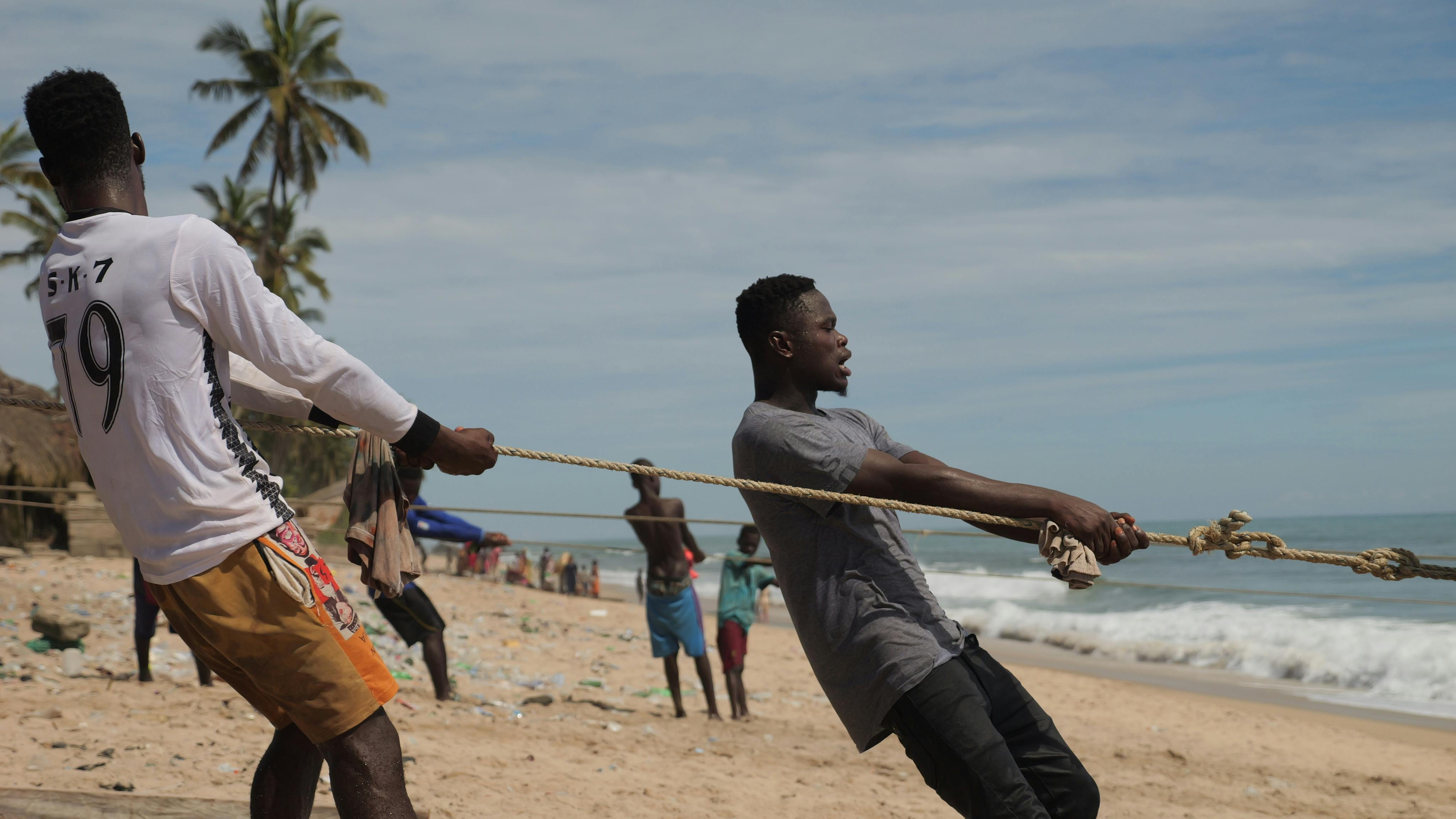 Men Pulling Rope on Beach · Free Stock Photo