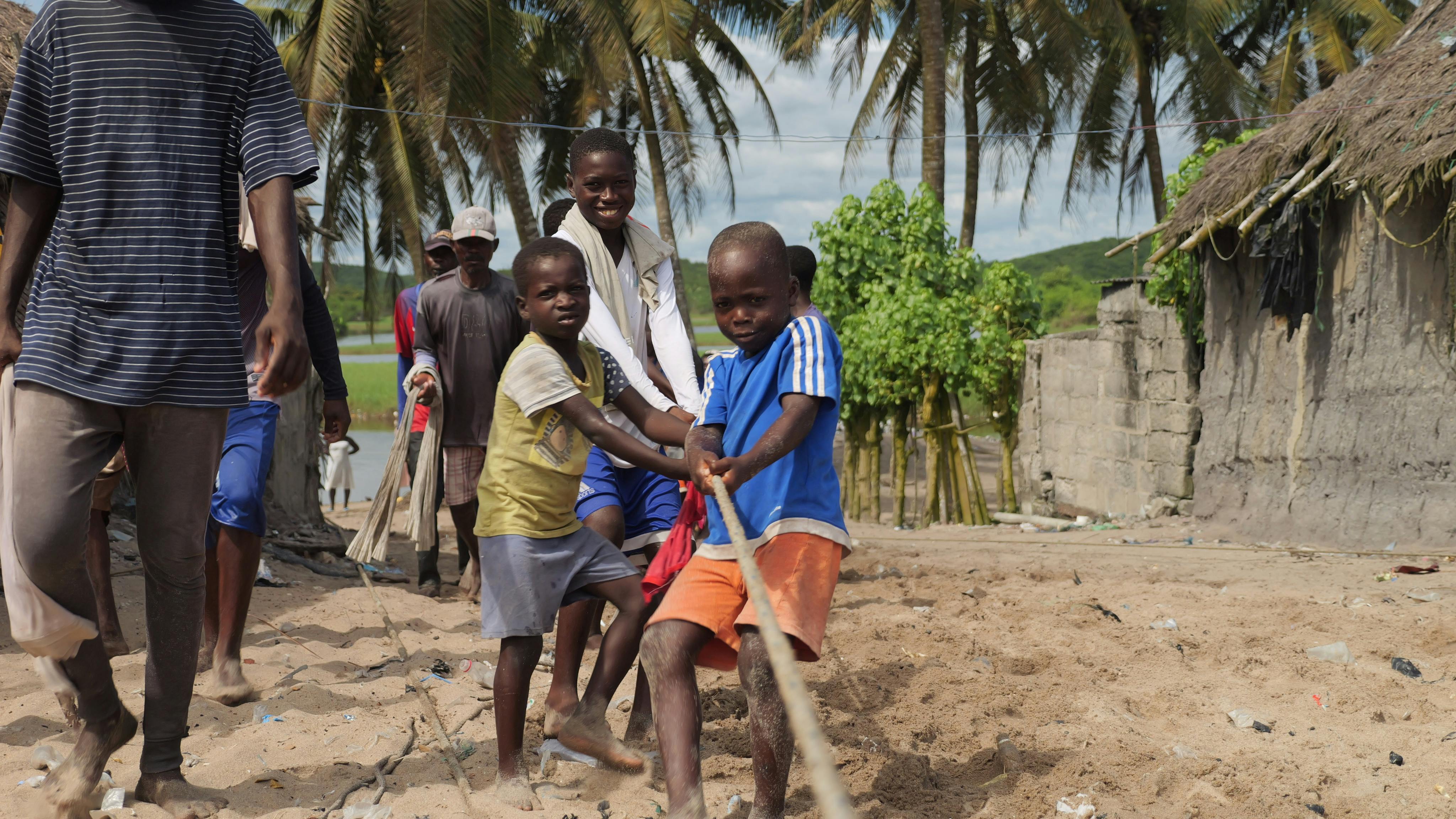 African Children Holding a Rope on a Beach · Free Stock Photo